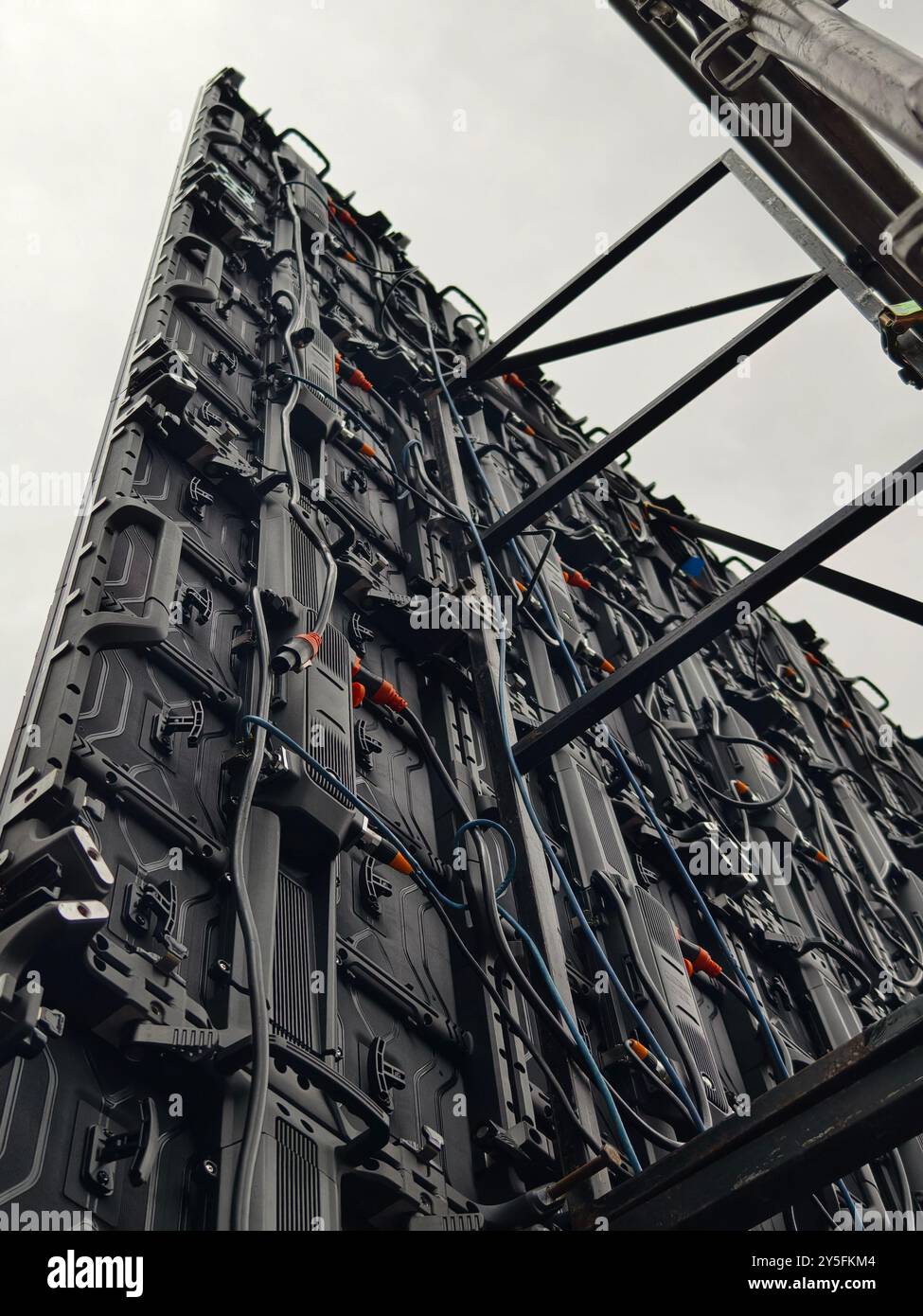 A bunch of electrical wires and connectors are hanging down from a led ...