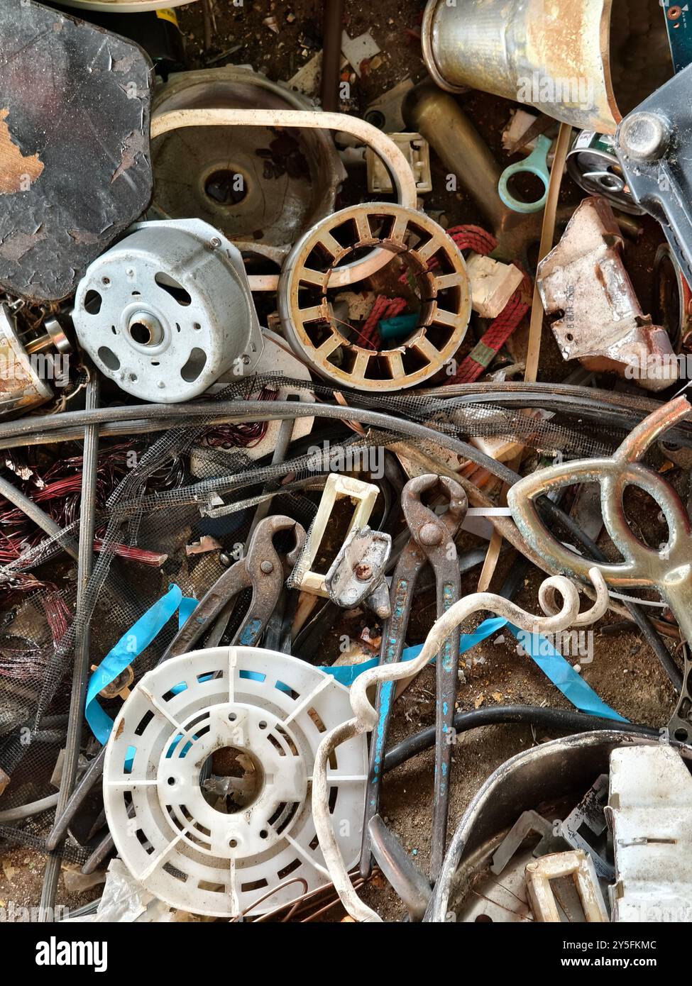 A pile of garbage with a bucket, rope, bottles, and other items at a ...