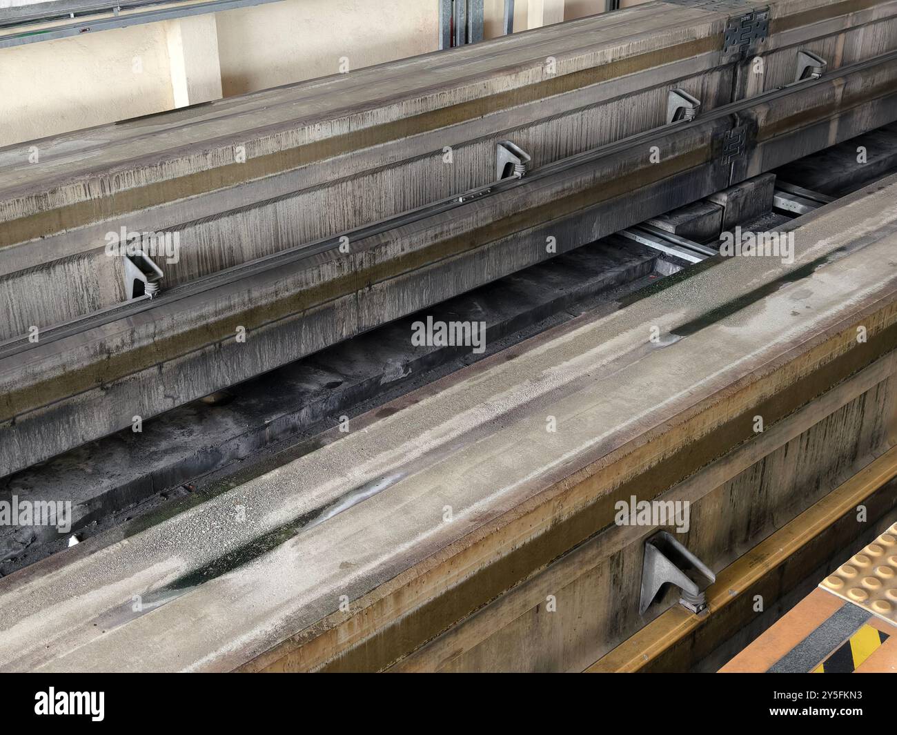 A long metal train tracks at a monorail station Stock Photo - Alamy