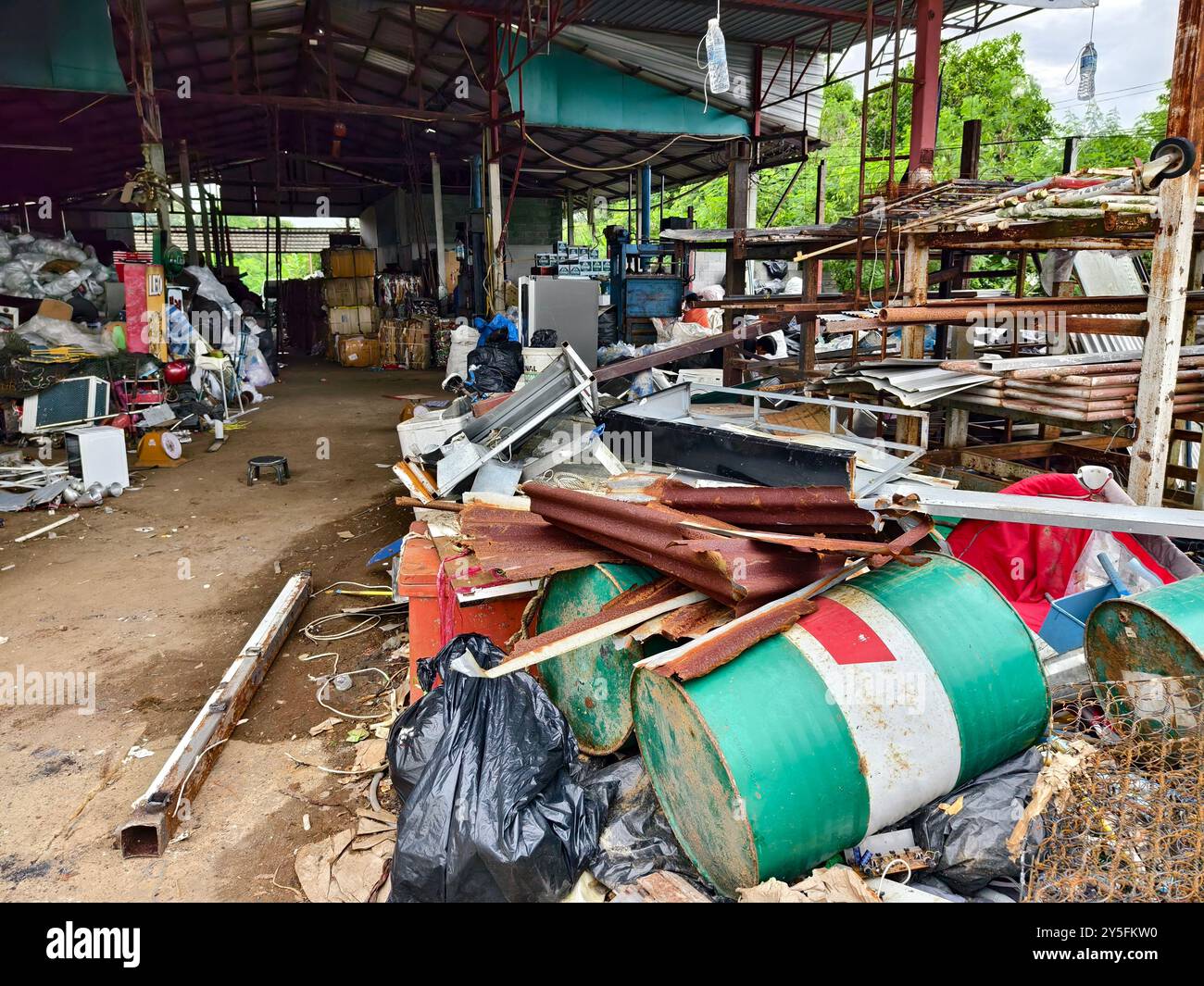 A pile of garbage with a bucket, rope, bottles, and other items at a ...