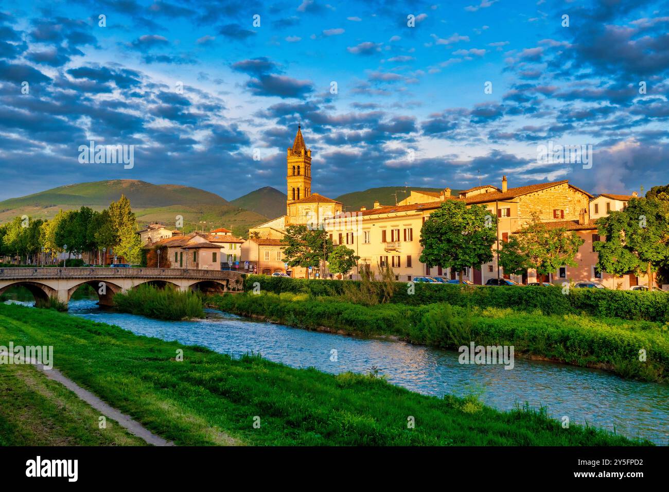 View of the River Topino and the Chiesa di San Giacomo at sunset ...