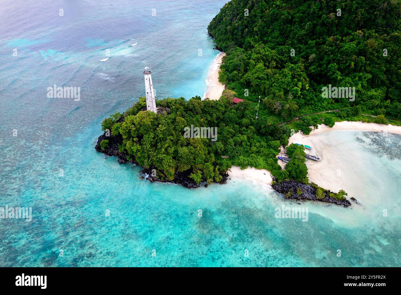 Aerial view of a beautiful lighthouse, sandy beach and fishing boats ...