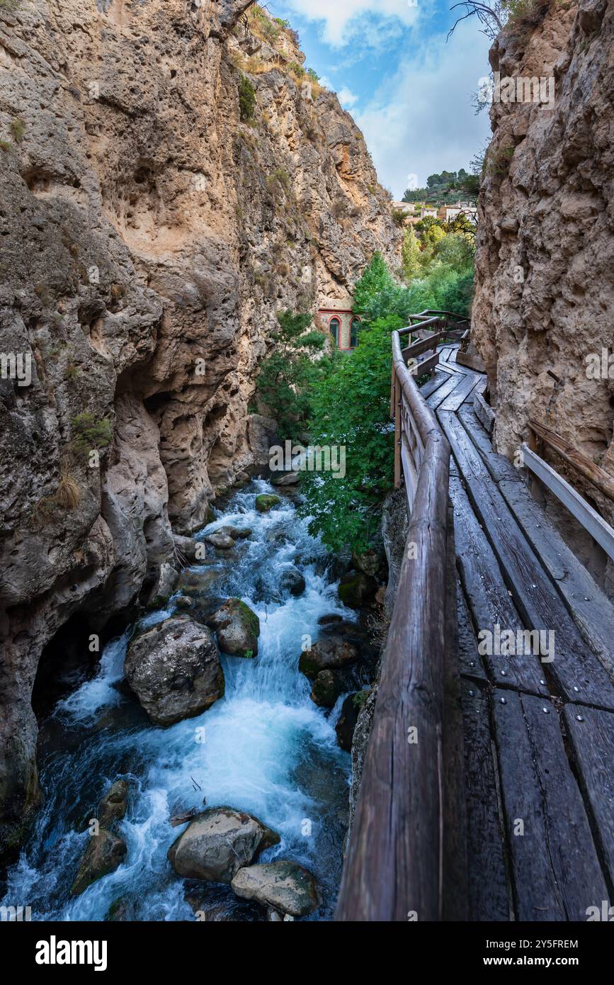 Wooden walkway located on the rock wall and several meters high in the ...