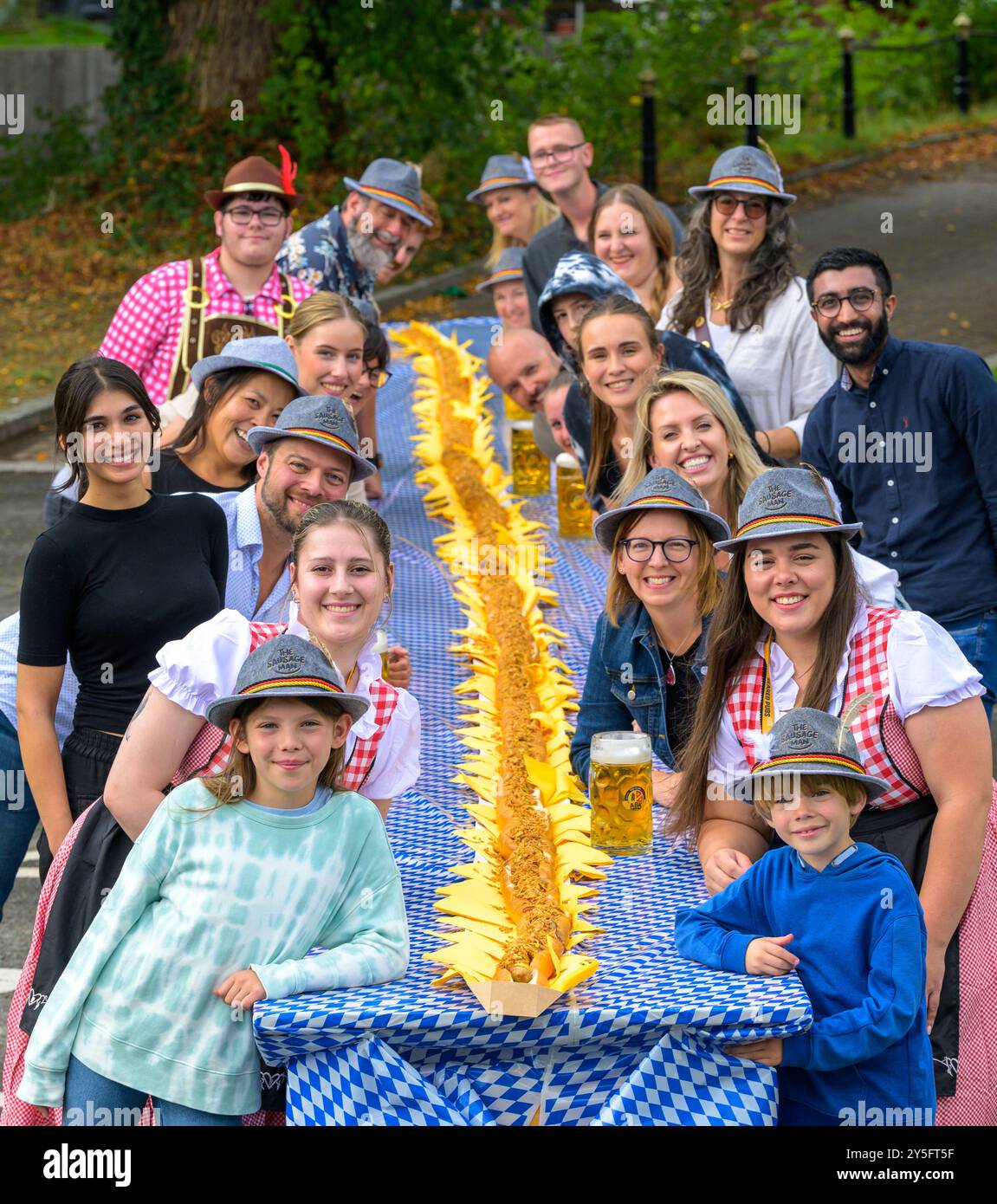 EDITORIAL USE ONLY A group of pub goers hold up a 12.12m long bratwurst ...