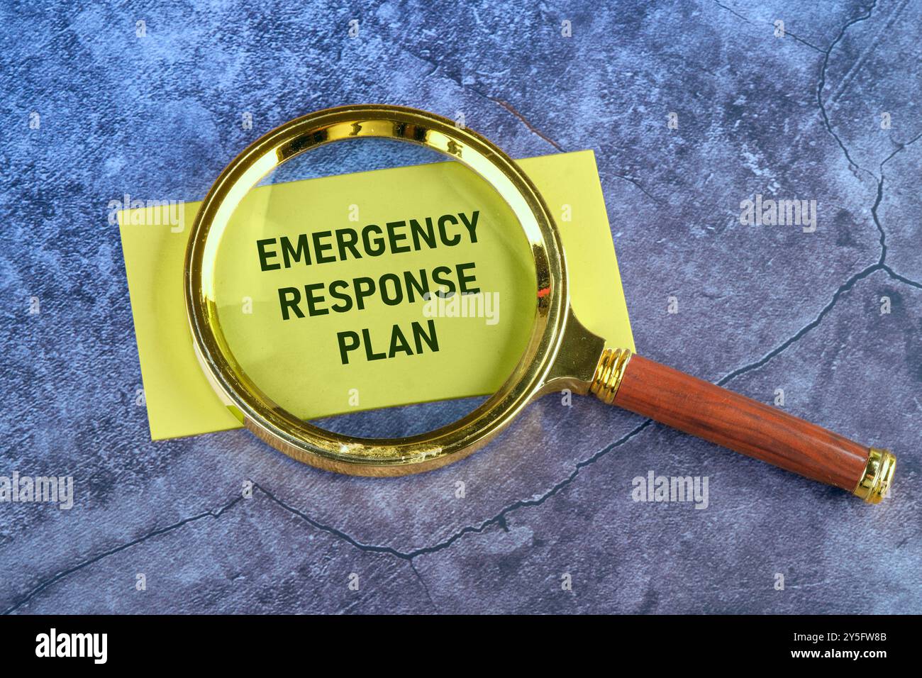 ERP as EMERGENCY RESPONSE PLAN written through a magnifying glass on a ...