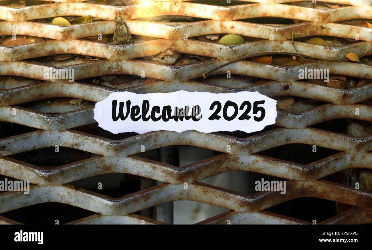 Welcome 2025 note on torn paper with sunlight. New year concept with ...