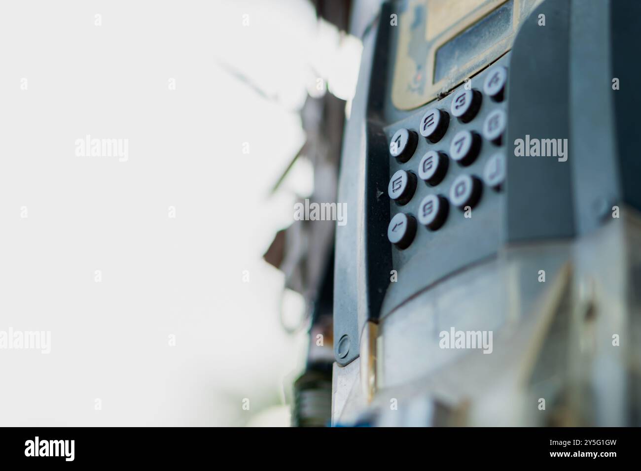 Close-up of a vintage payphone keypad with blurred background ...