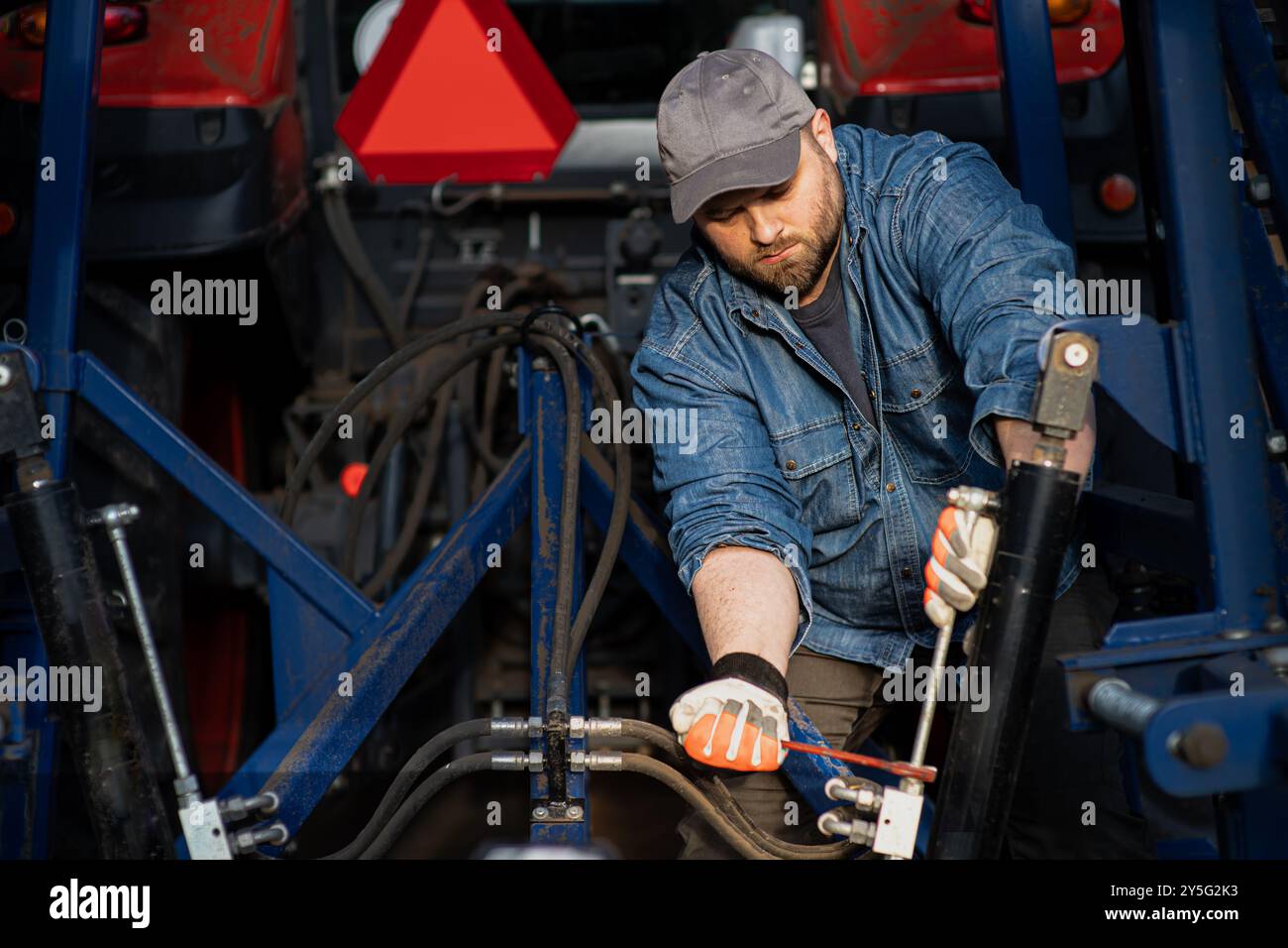 Farmer repairs agricultural machines hi-res stock photography and ...