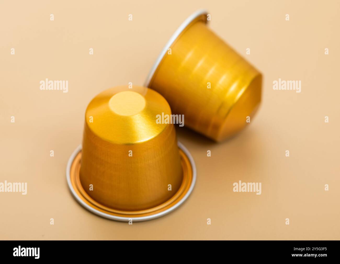 Aluminium coffee capsules pods for coffee machine on beige background ...