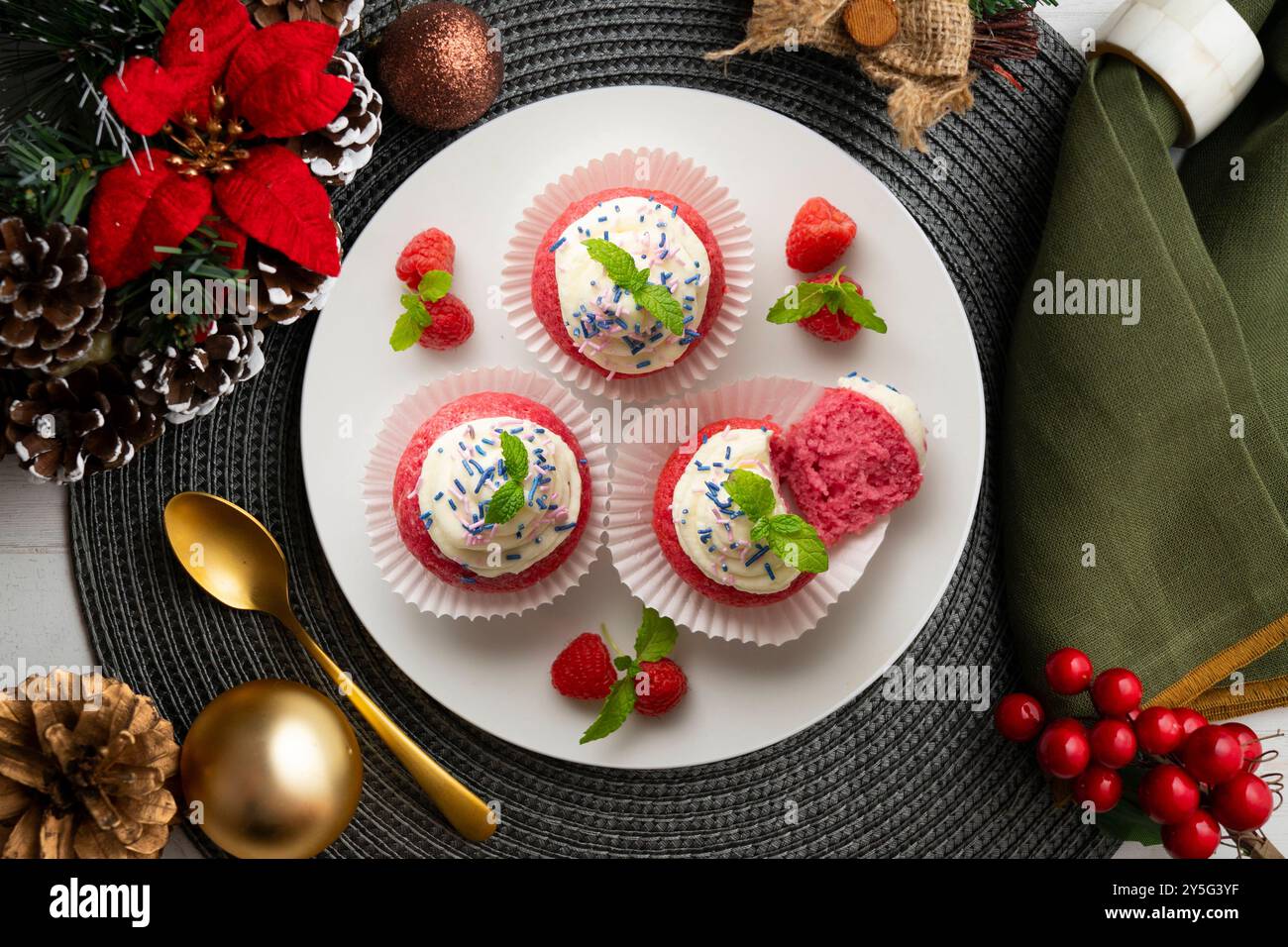 Red velvet muffins with sweet and caramel frosting. Top view table with ...