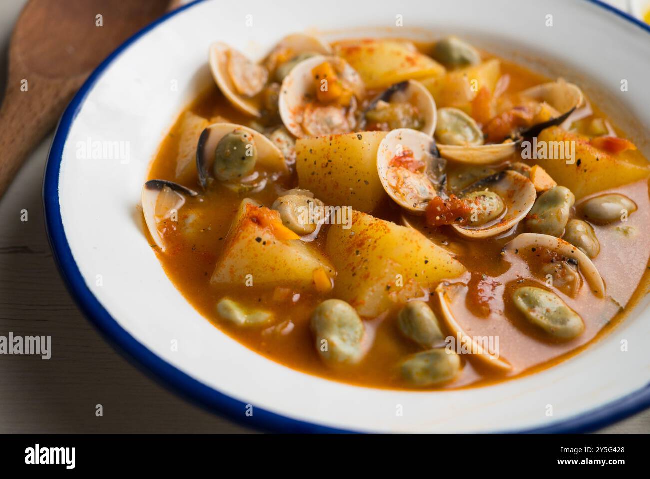Fish stew with clams, potatoes and green beans. Traditional Spanish ...