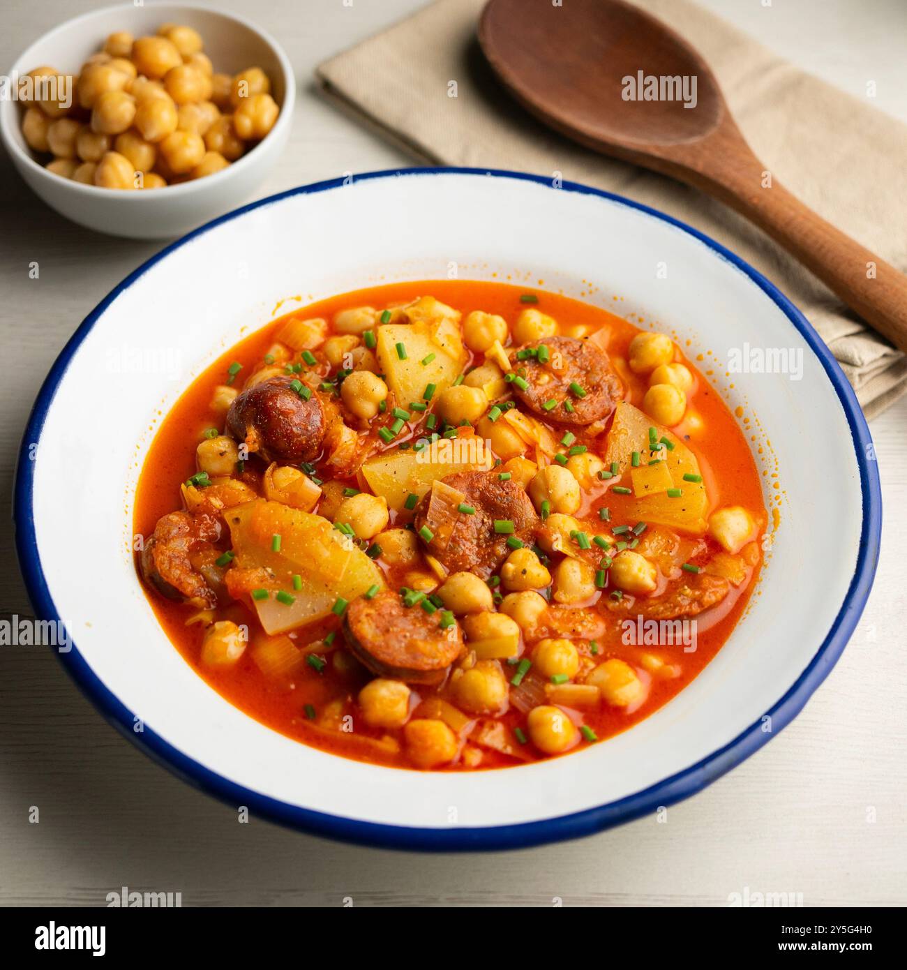 Chickpea stew with vegetables and chorizo. Traditional Spanish tapa ...