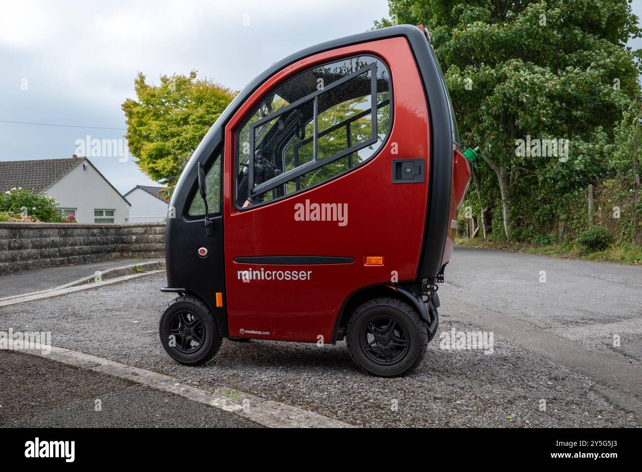 Red Mini Crosser X2 Cabin Mobility Scooter Stock Photo - Alamy