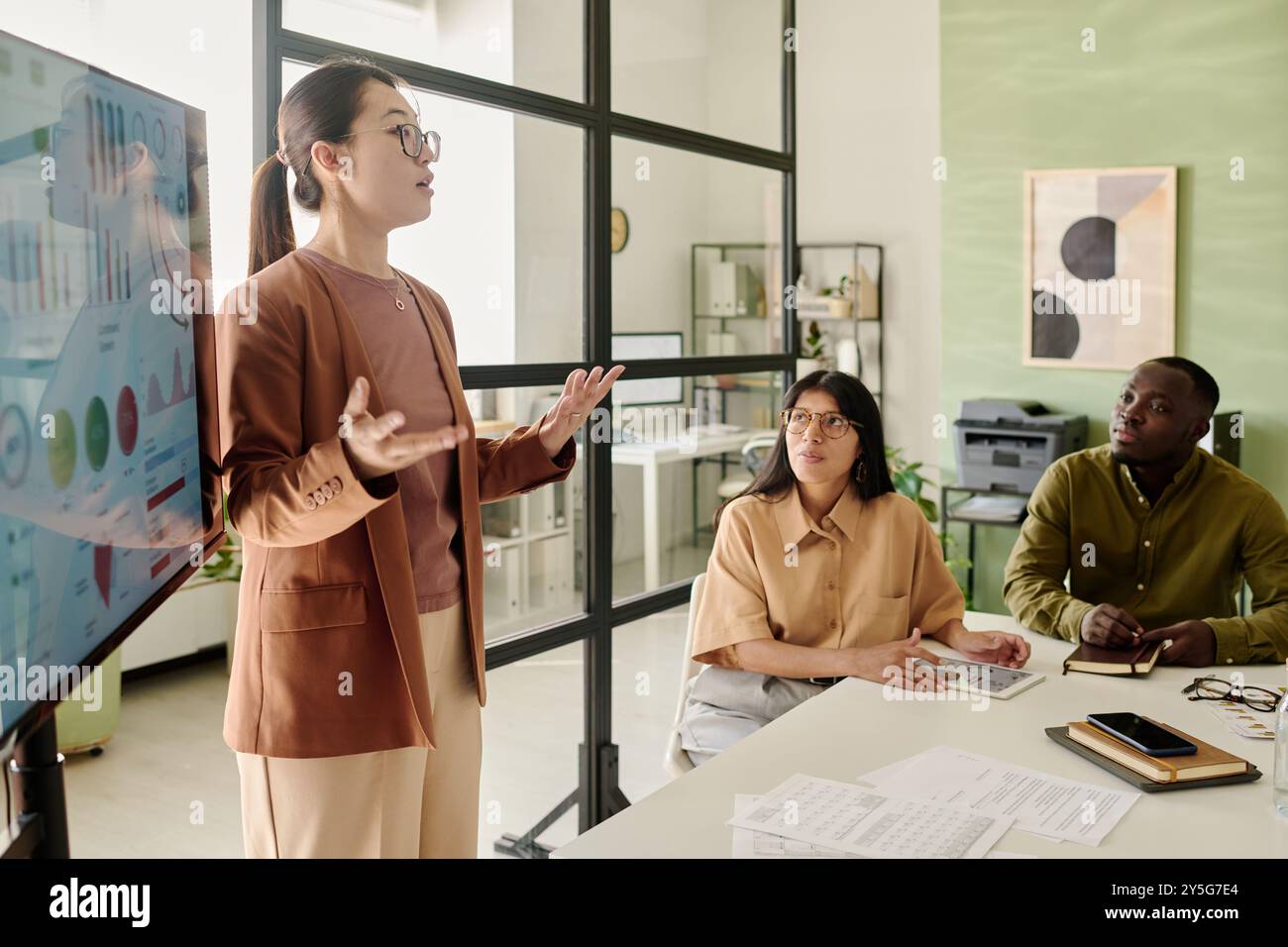 Multiracial team analyzing business data with professional presenting ...
