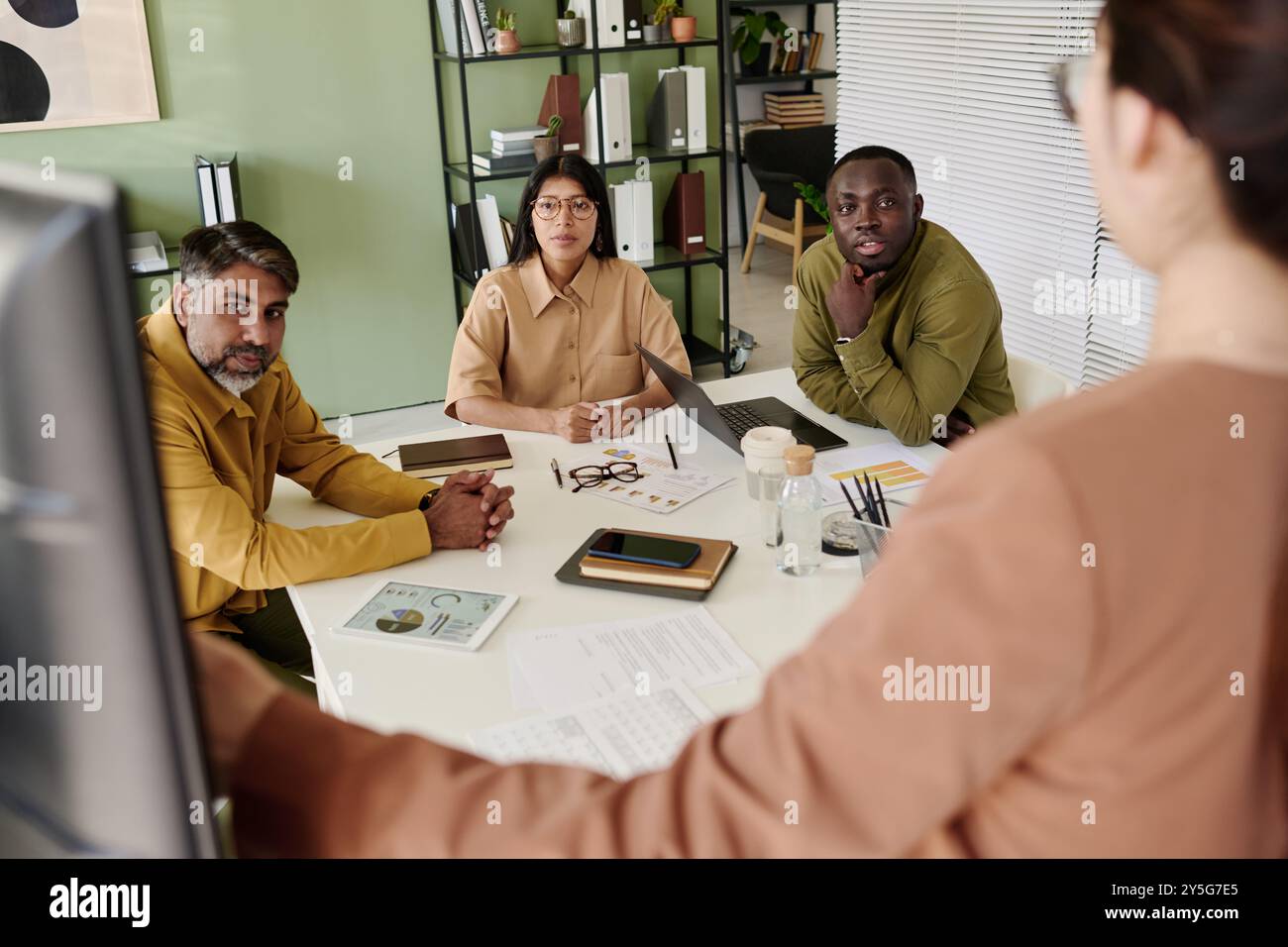Group of diverse professionals engaging in strategic discussion around ...