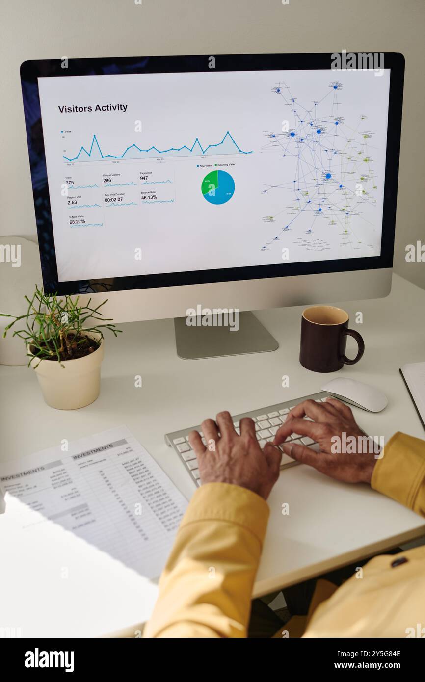Image shows person analyzing visitors activity data on large computer ...