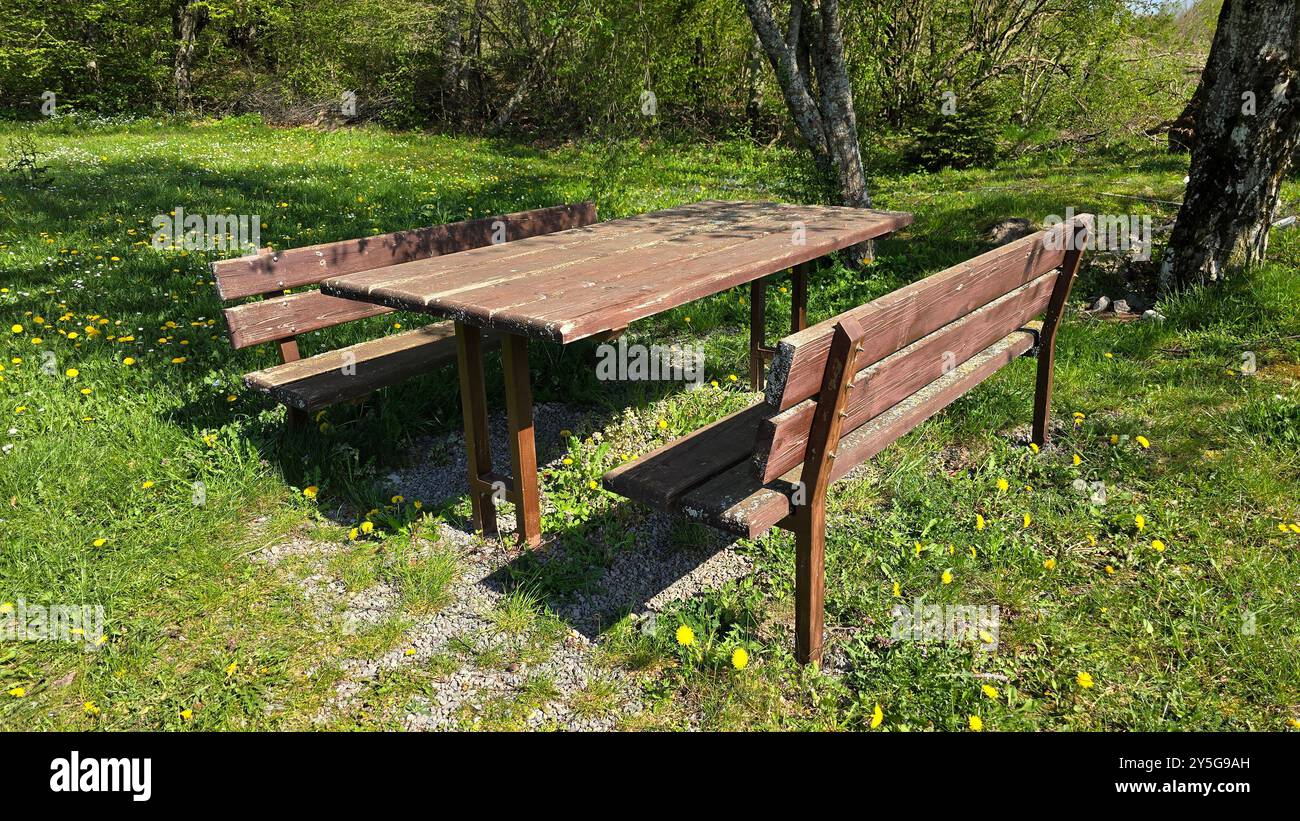 Dilapidated outdoor rural wooden table with two benches and metal frame ...