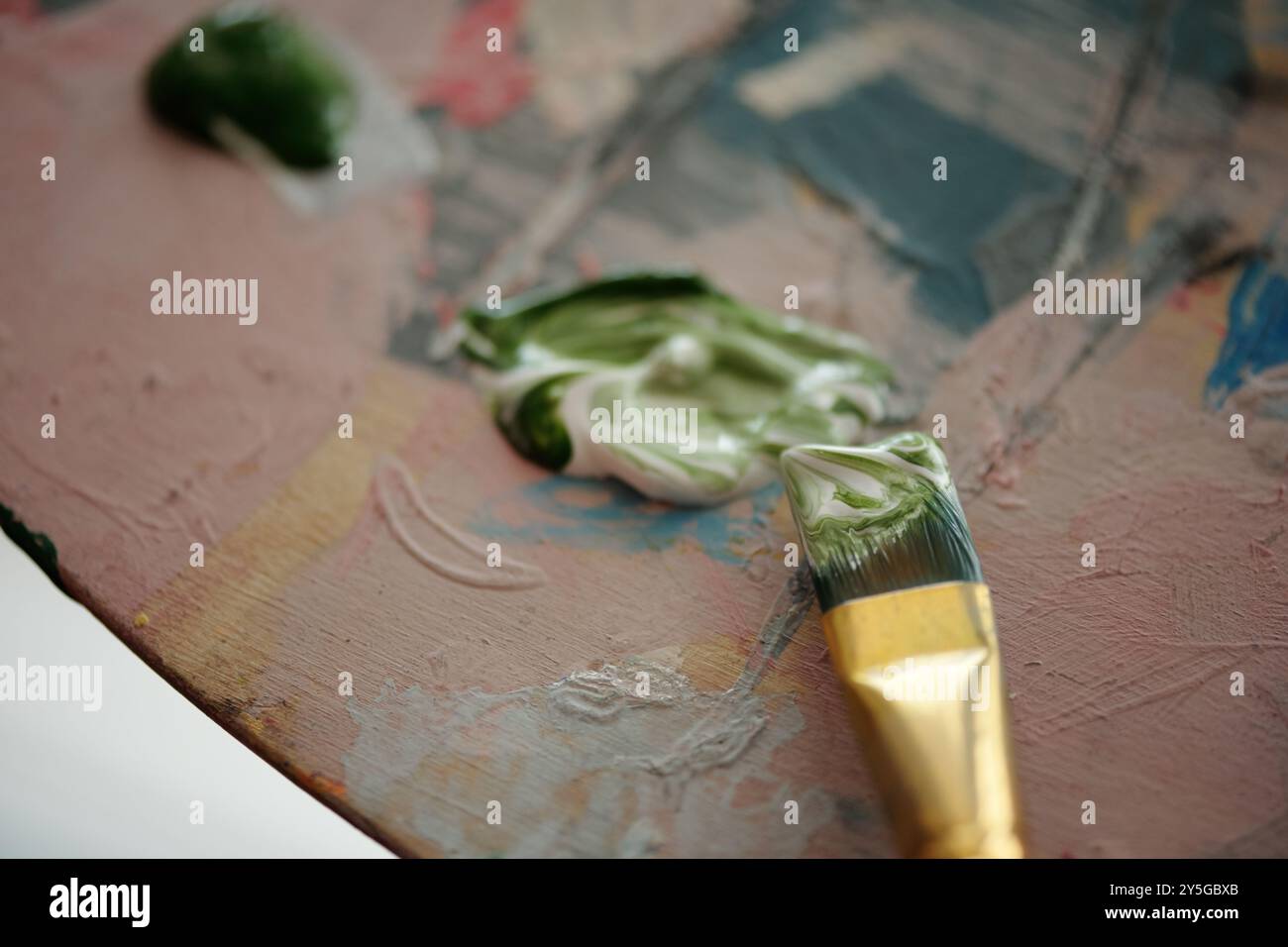 Artistic close-up showcasing paintbrush resting on paint palette with ...