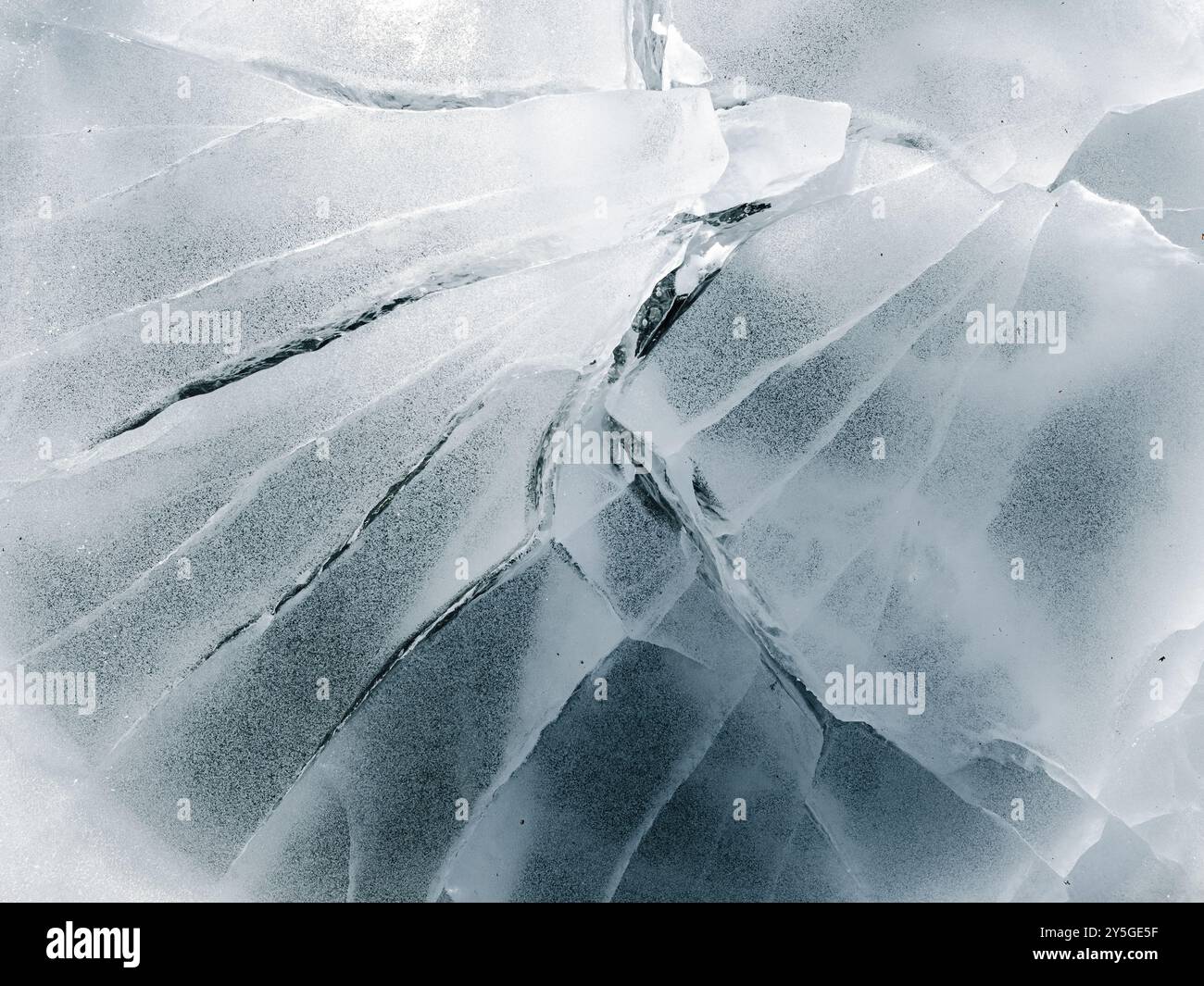 Abstract ice texture. Blue cold background with cracks on the frosty ...