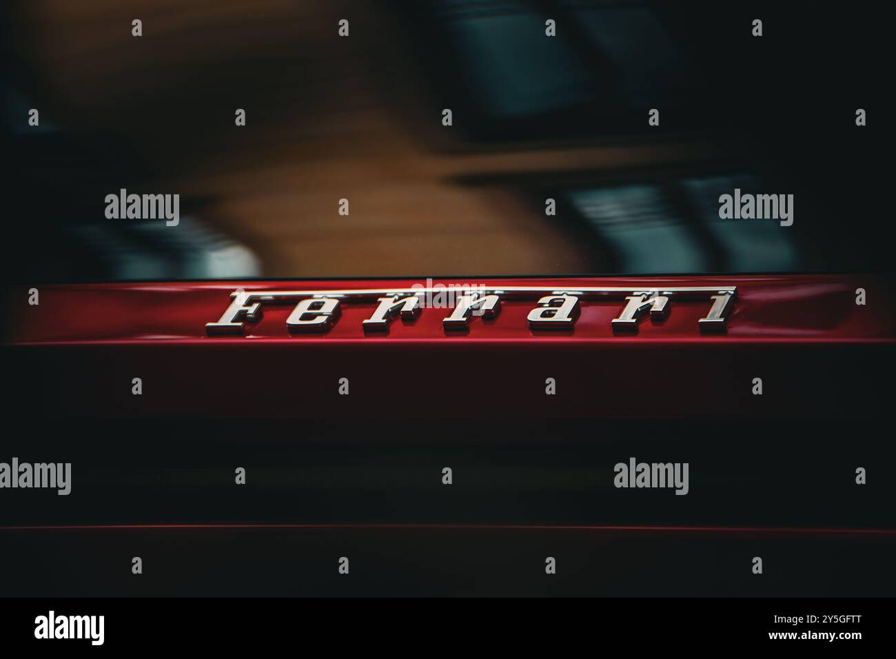 Close-up of the Ferrari logo on a sleek red surface, highlighting the ...