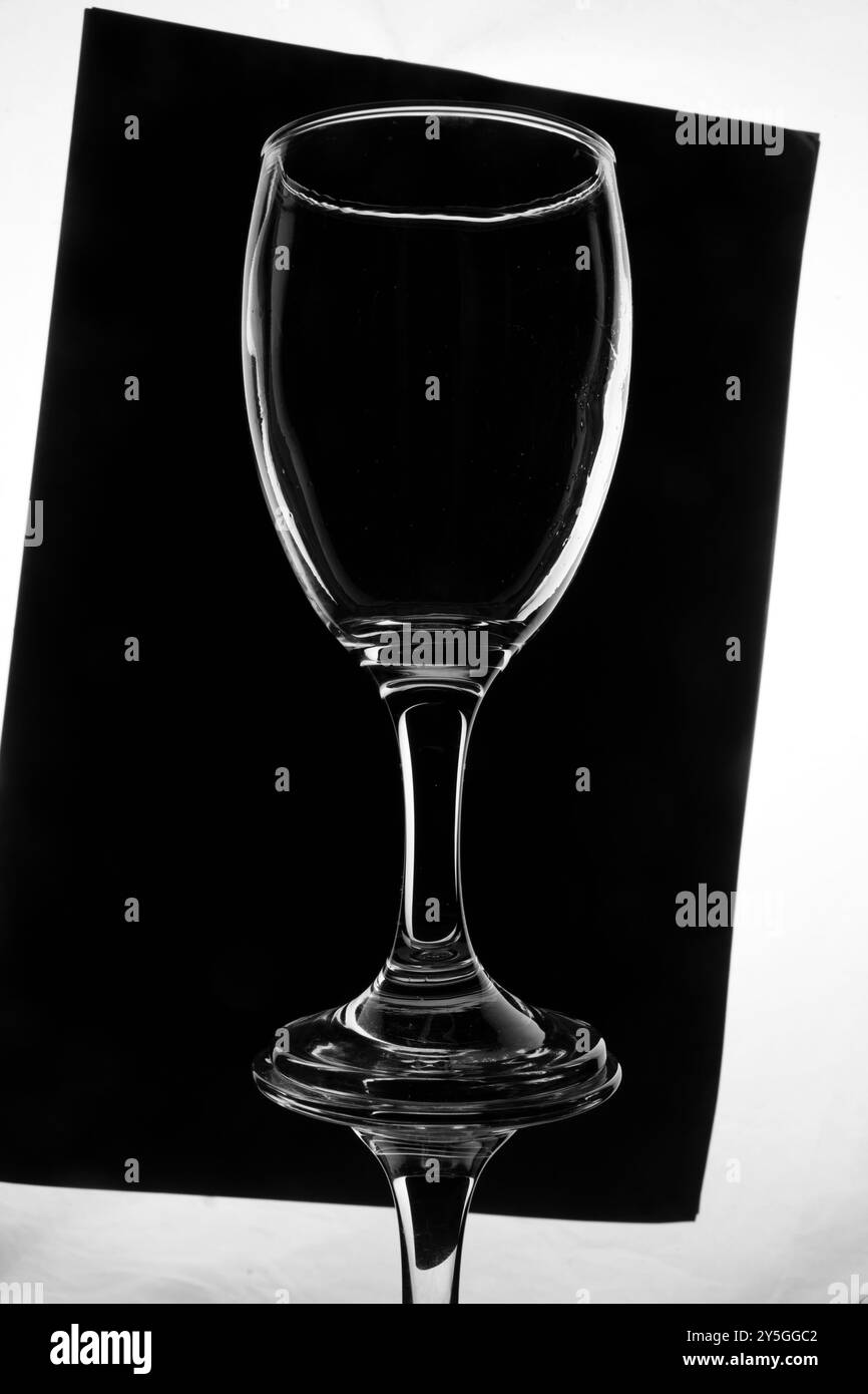 pouring water Empty wine glass isolated on black and white, glass use ...
