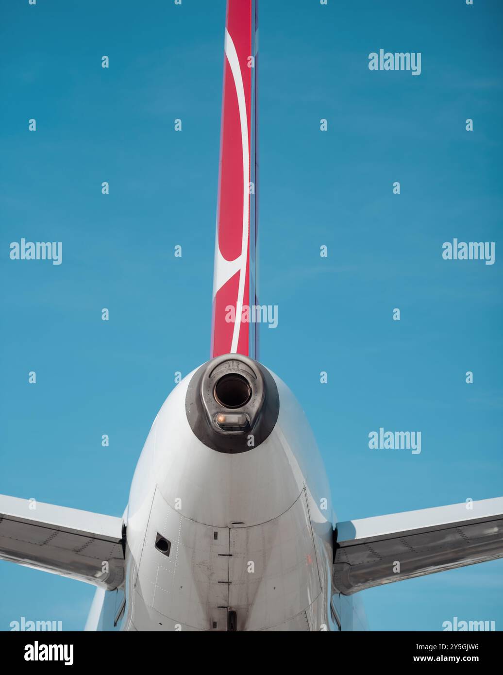 Turkish Airlines plane’s red tail fin on a sunny day. Vertical ...