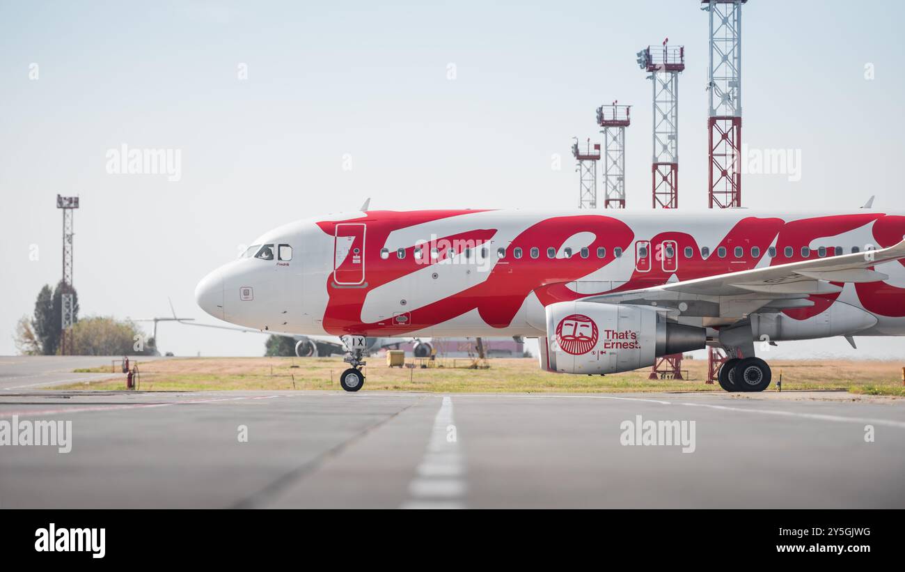 Ernest airlines Airbus A320 taxiing at airfield after landing. Side ...