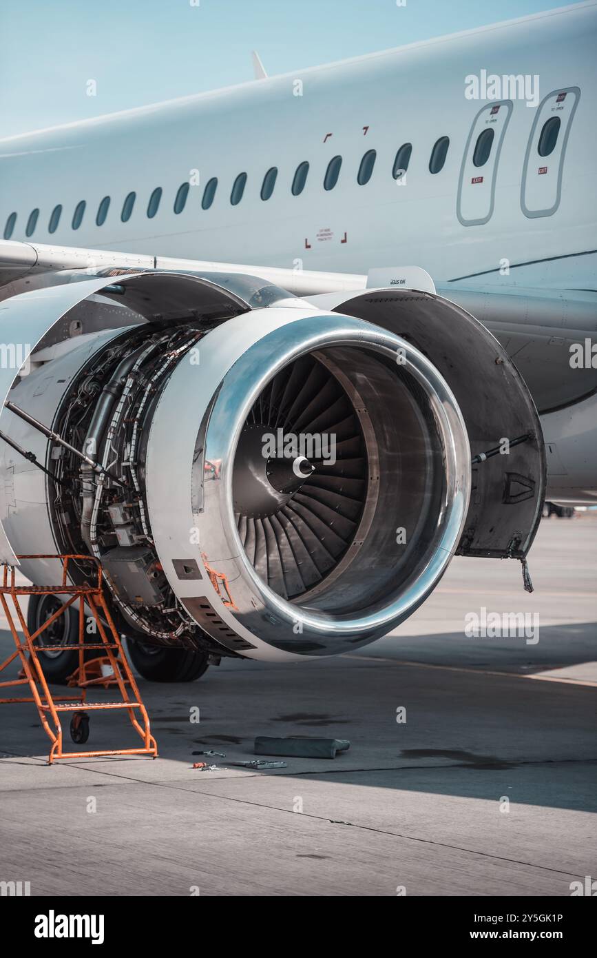 Airplane engine maintenance. White passenger aircraft on airport apron ...