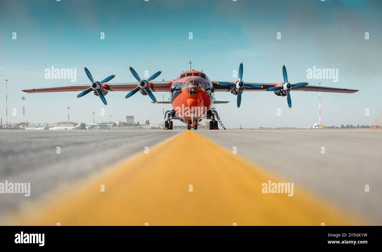 Orange An-12 facing camera. Bright yellow line leading to turboprop ...