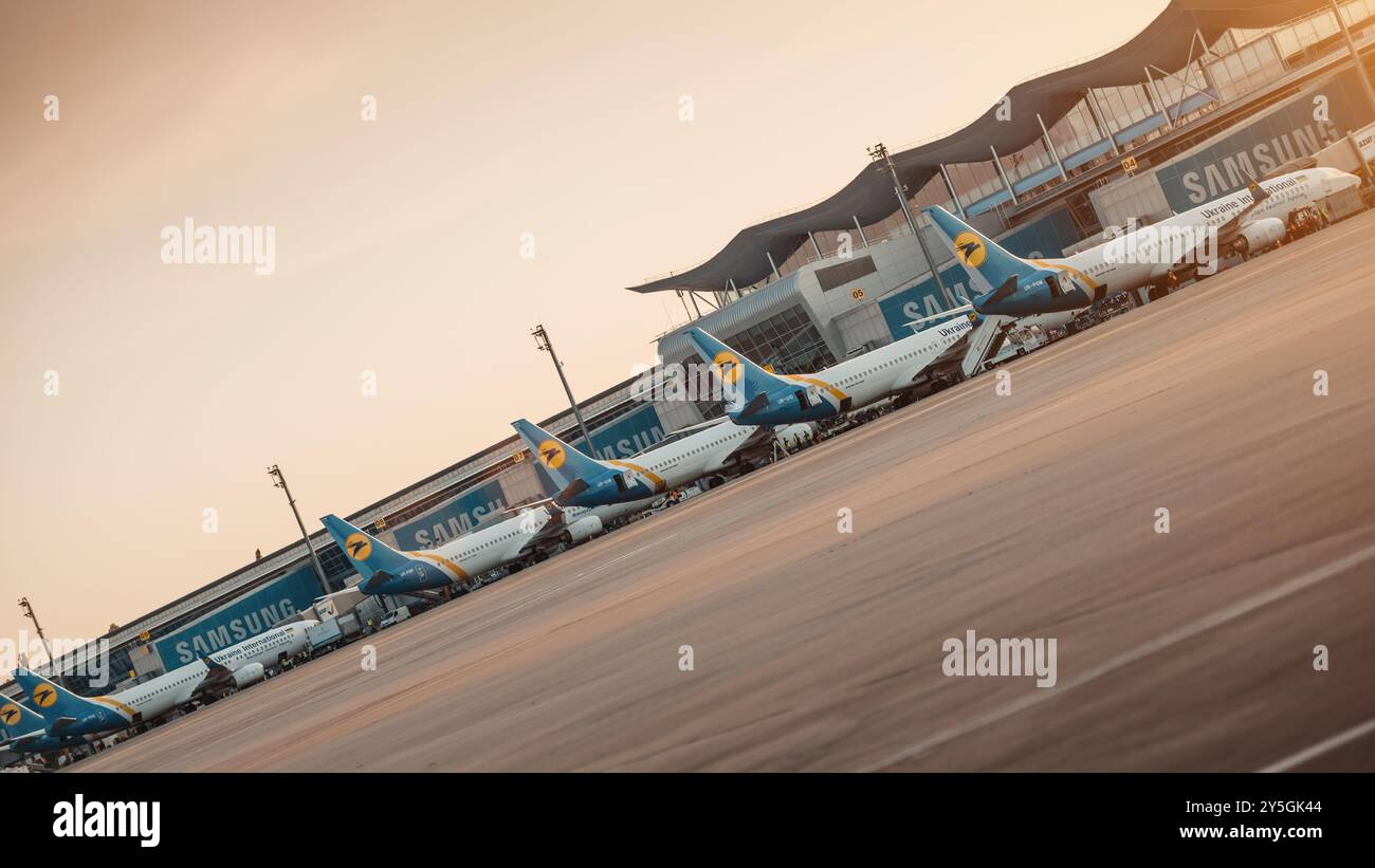 Airport terminal at sunset. View from apron at long airport building ...