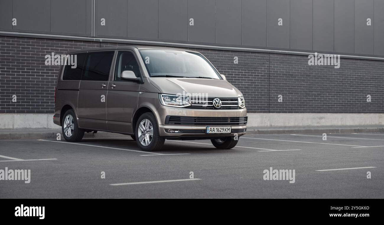 Brown VW Transporter in front of grey wall. Front three quarter view of ...