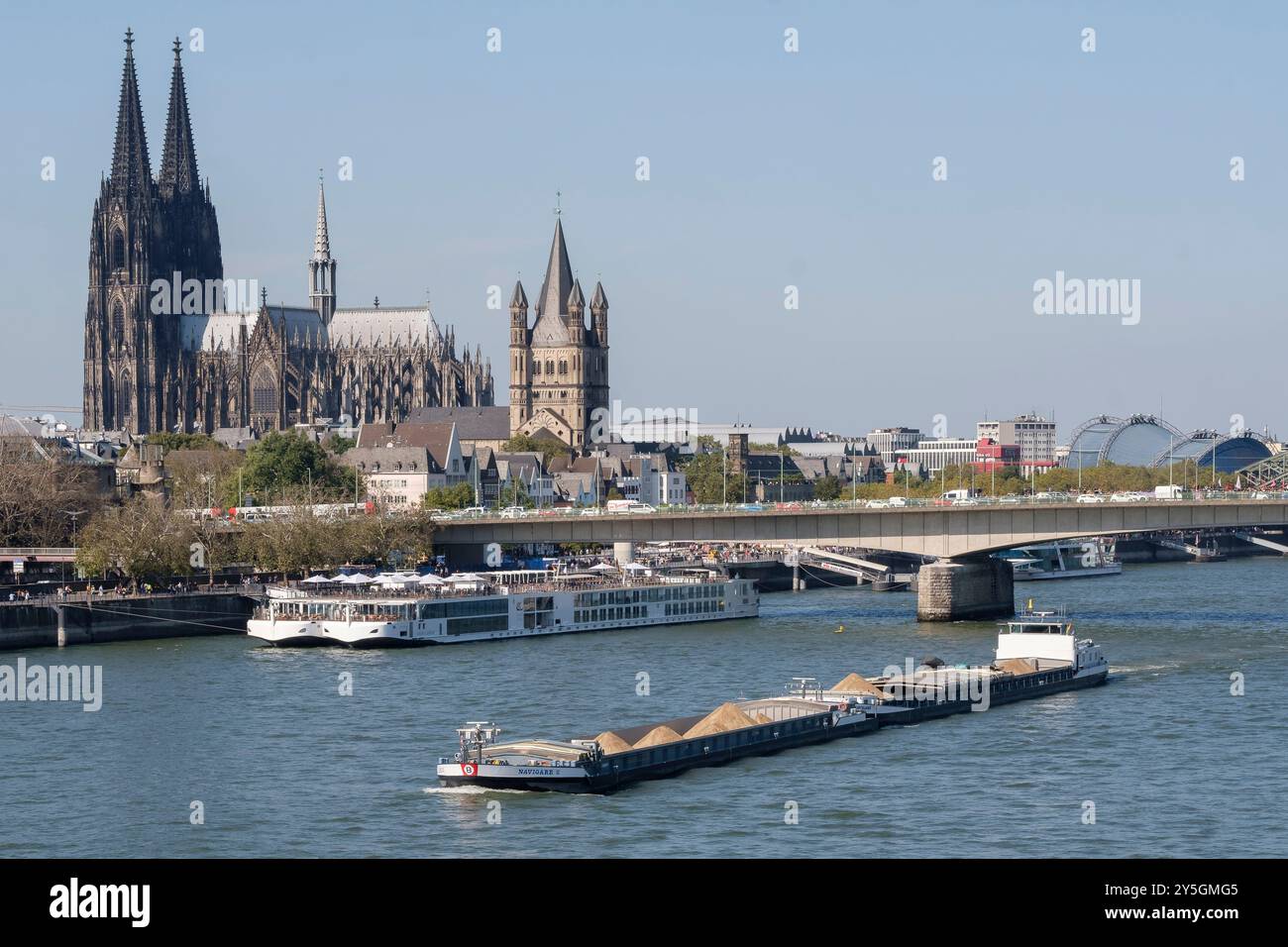 Push boat on the Rhine in front of Cologne Cathedral and St Martin's ...