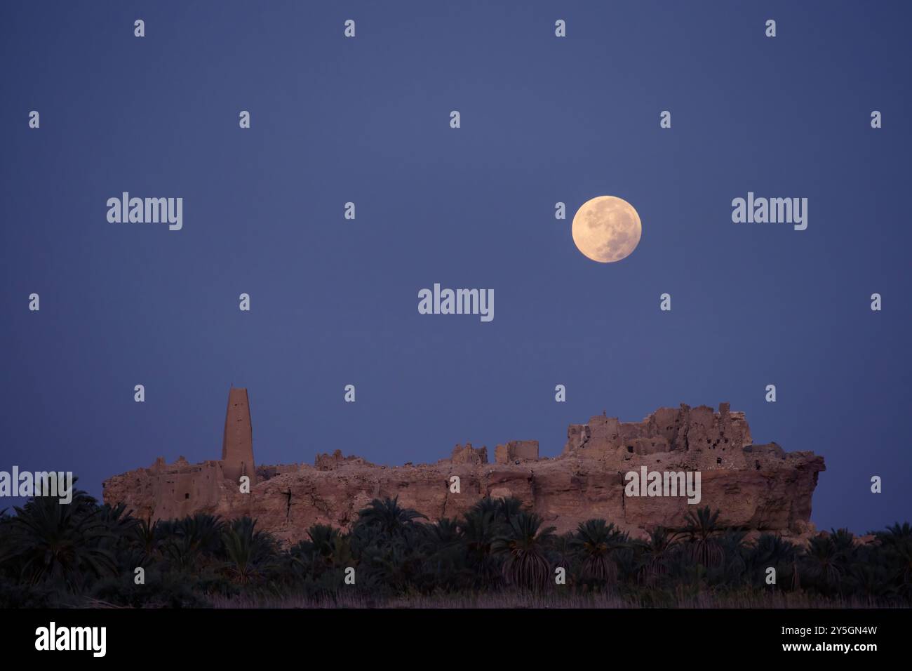 September's Full Moon known as the Harvest Moon is seen setting over ...