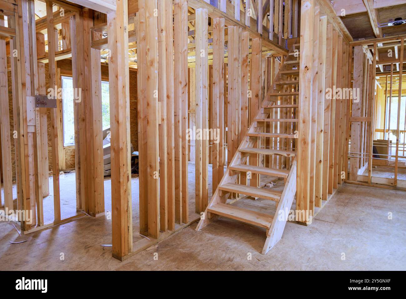Interior of newly constructed house with wooden stud timber framing ...
