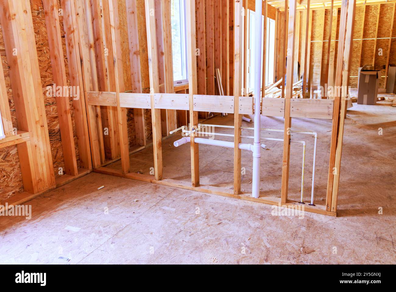 Interior of newly built house with wood studs supporting beam is ...