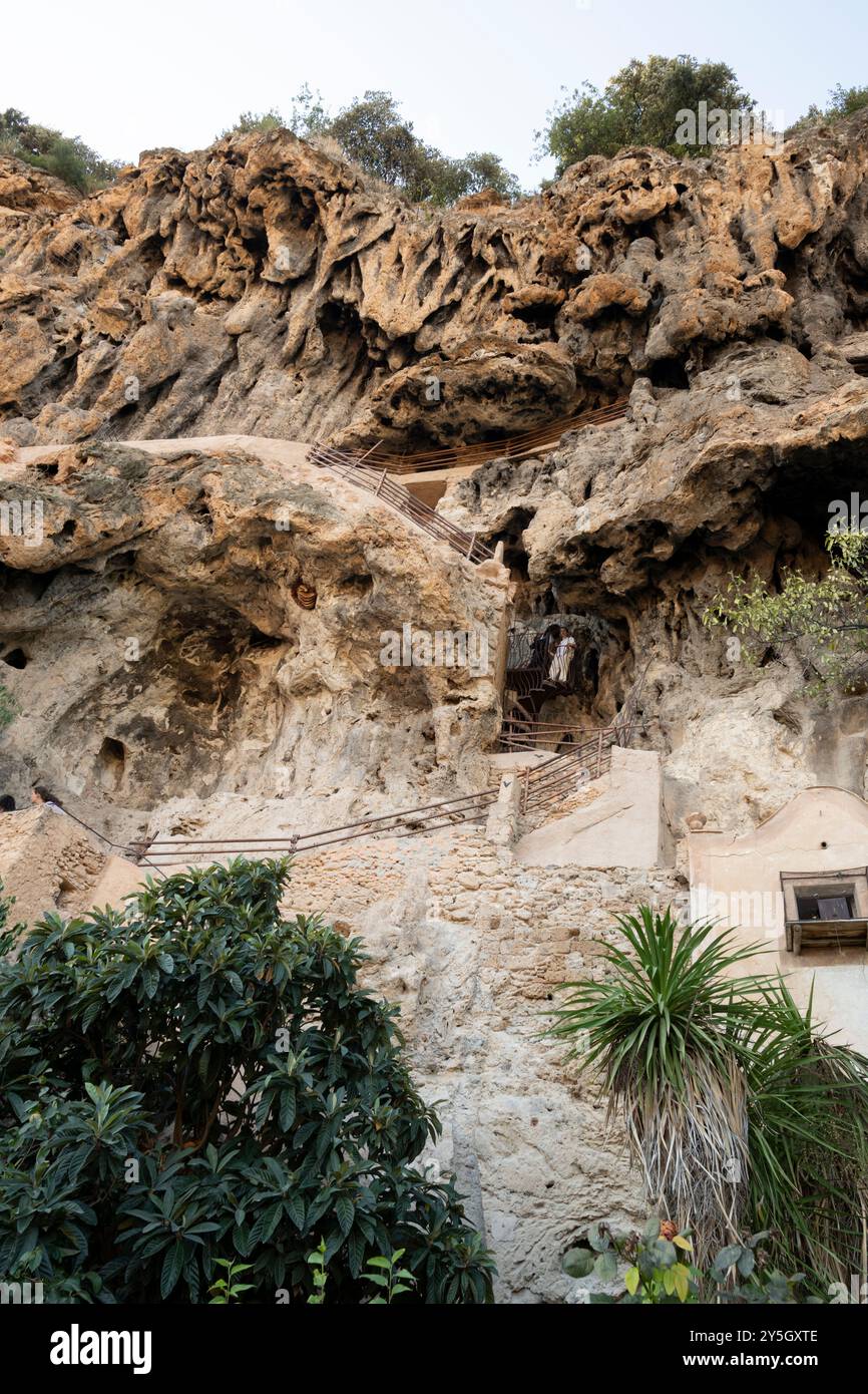 Cotignac's striking tuff rock rises 80m, home to troglodyte caves and ...