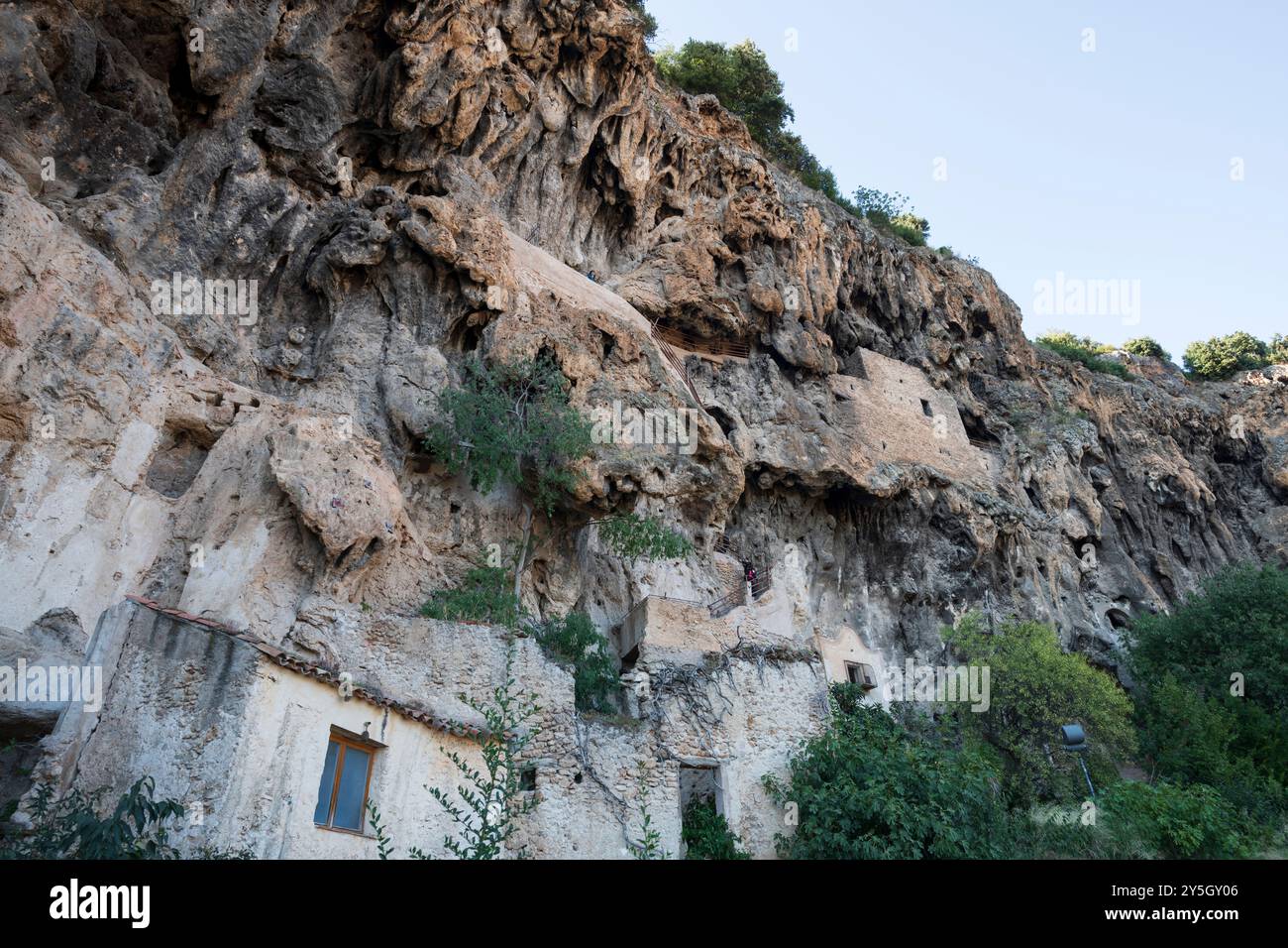 Cotignac's striking tuff rock rises 80m, home to troglodyte caves and ...