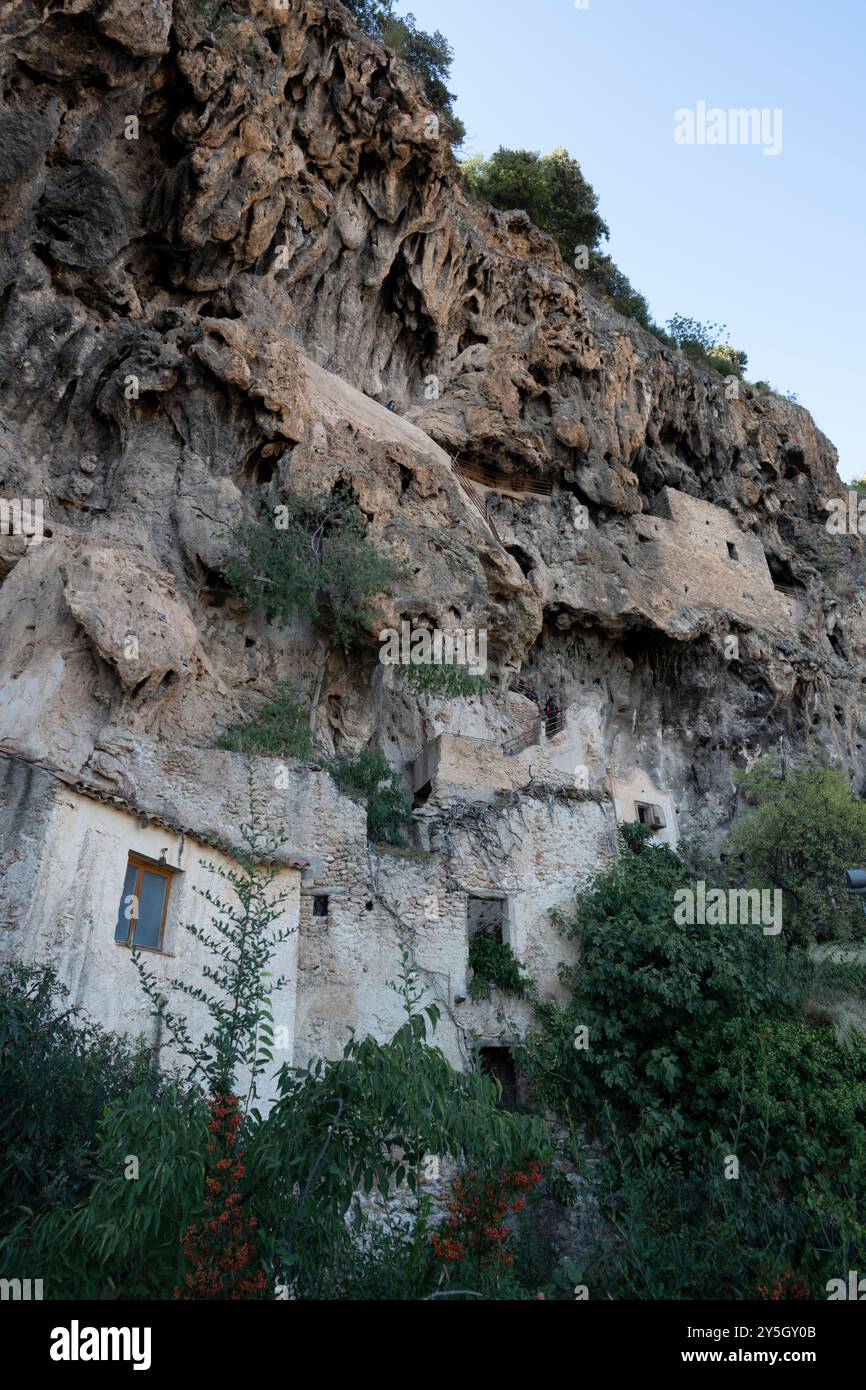 Cotignac's striking tuff rock rises 80m, home to troglodyte caves and ...