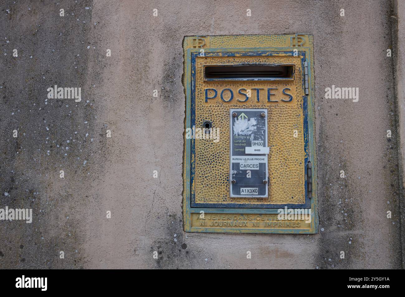 A yellow LA POSTE post box embedded in a wall in Cotignac, Var, South ...