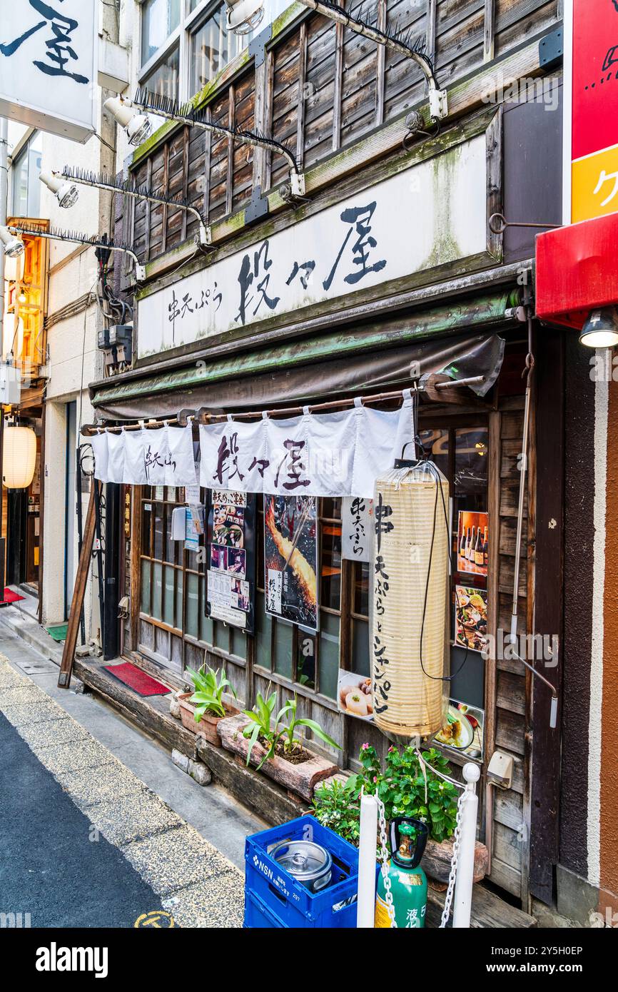 Traditional wooden facade of small Japanese Izakaya restaurant in the ...