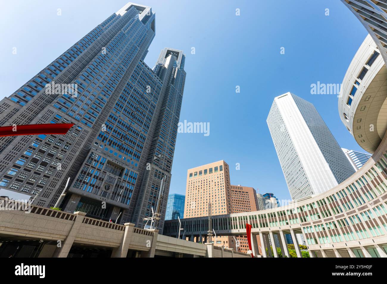 The Tokyo metropolitan building towering up to the blue sky with ...