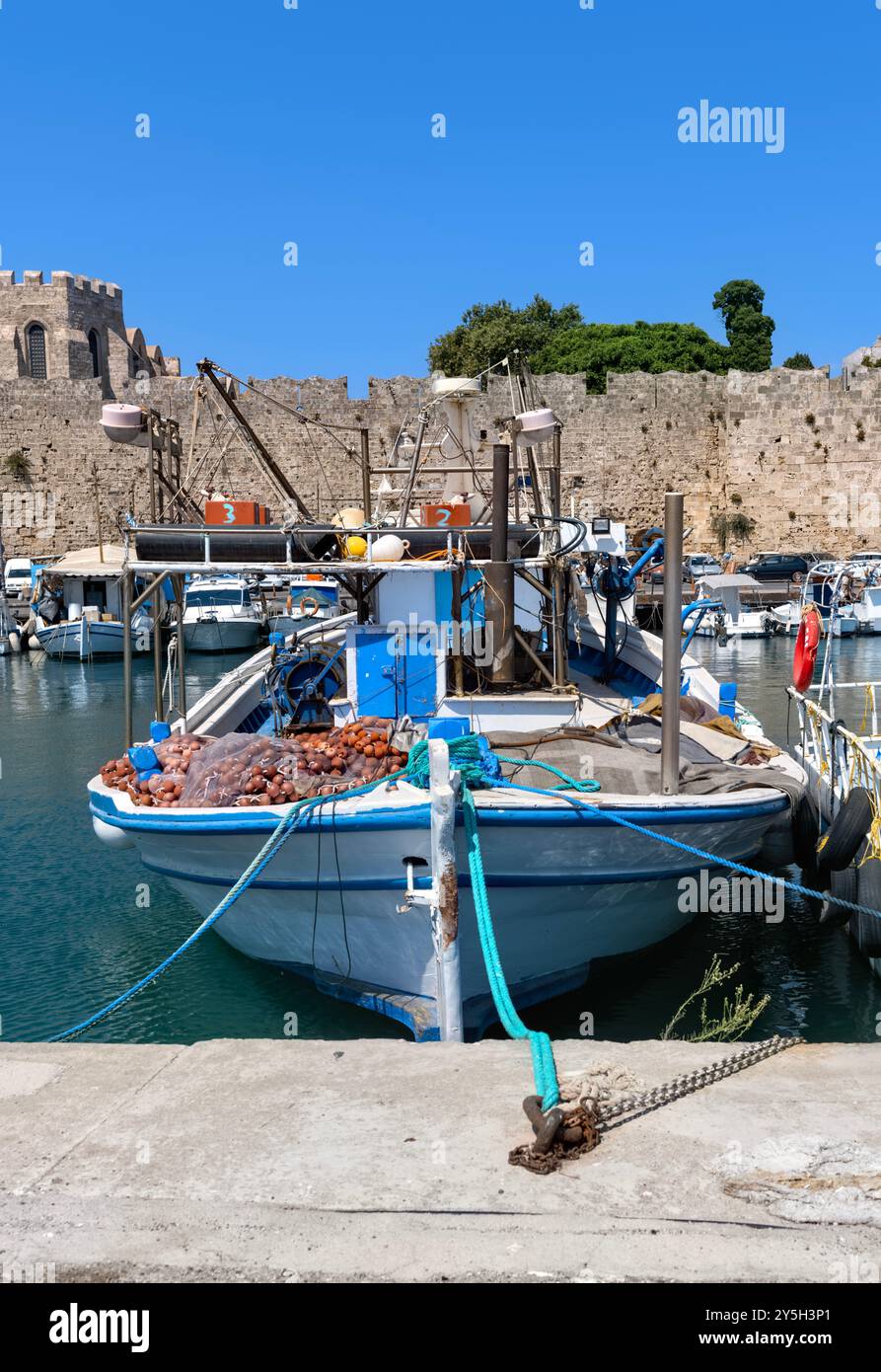Fishing boats at Kolona Harbour and City Walls, Rhodes, Greece Stock ...