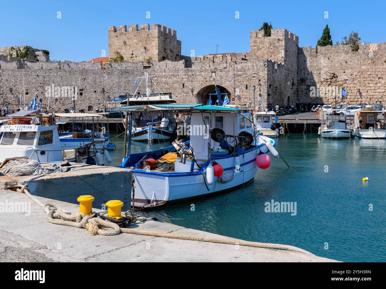 Fishing boats at Kolona Harbour and City Walls, Rhodes, Greece Stock ...