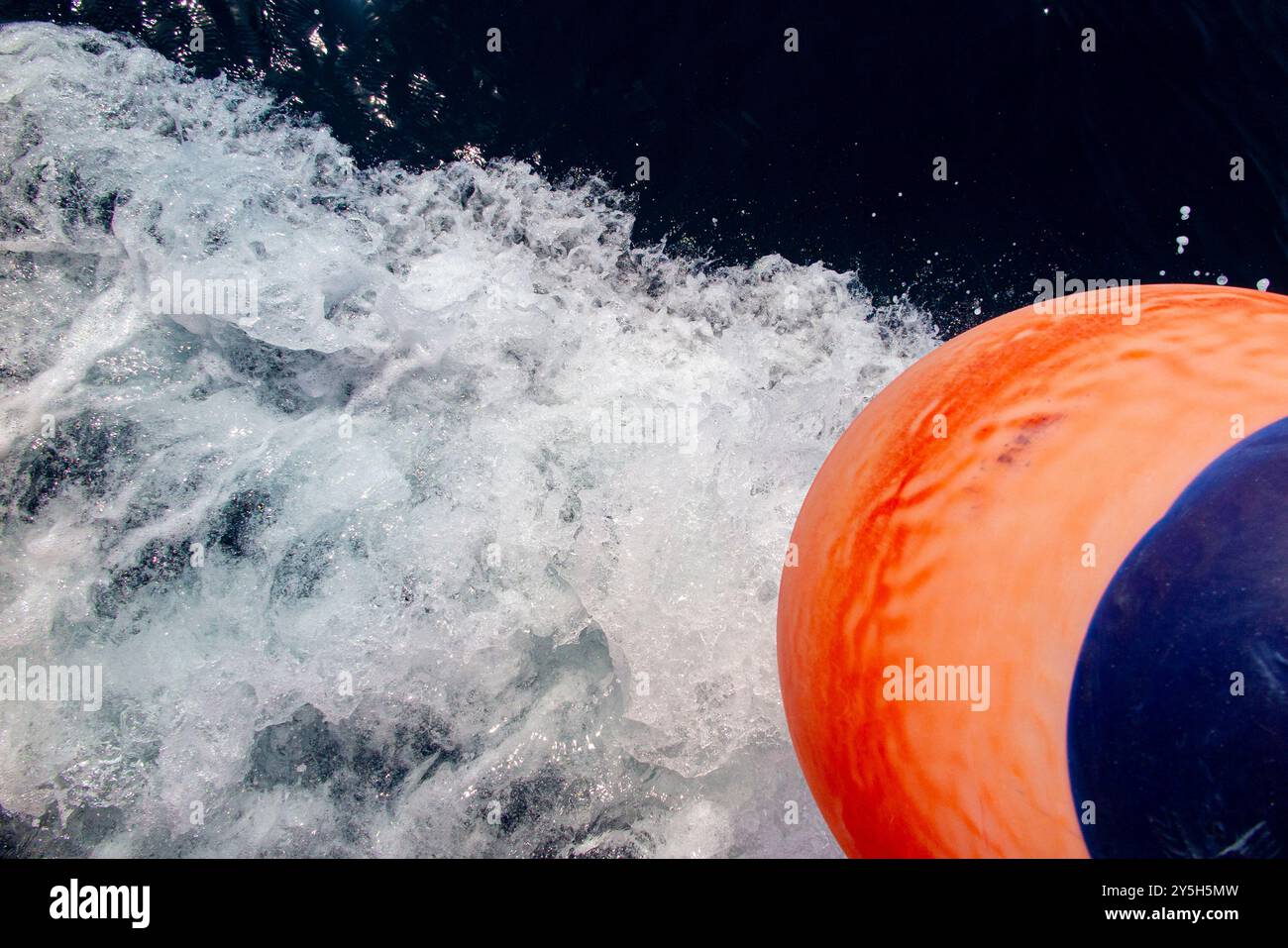 An orange buoy on a boat at sea with a bright blue sea Stock Photo - Alamy