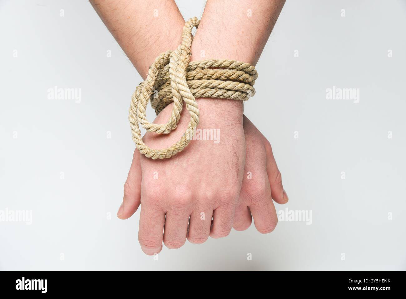 Two human hands tied with a rope close up view. Concept or projects ...