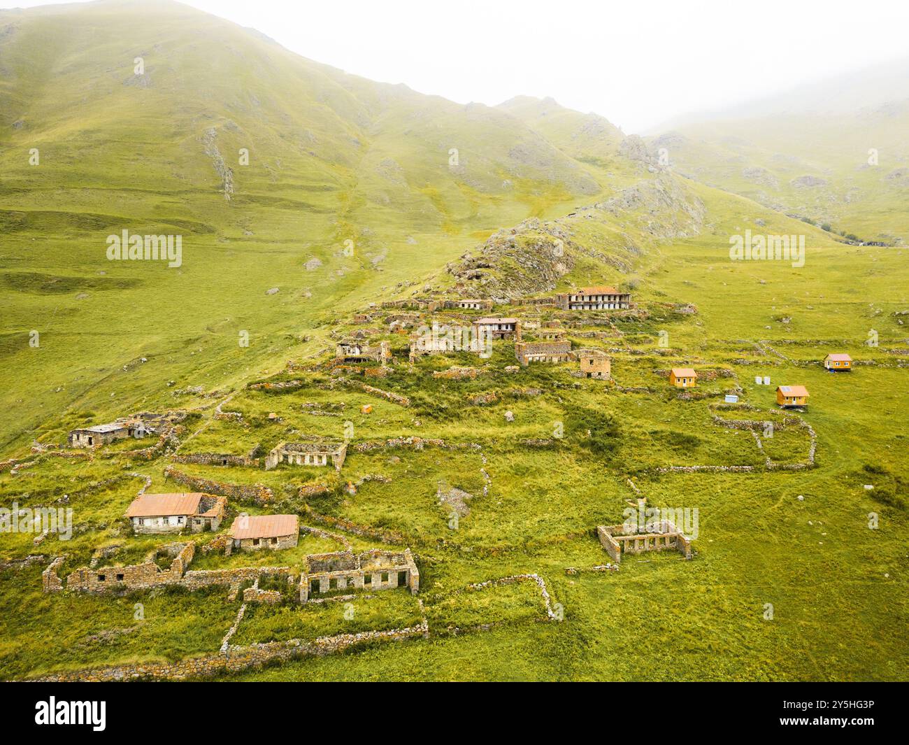 Aerial top view abandoned village of Arsha ruins on hillside. Kazbegi ...