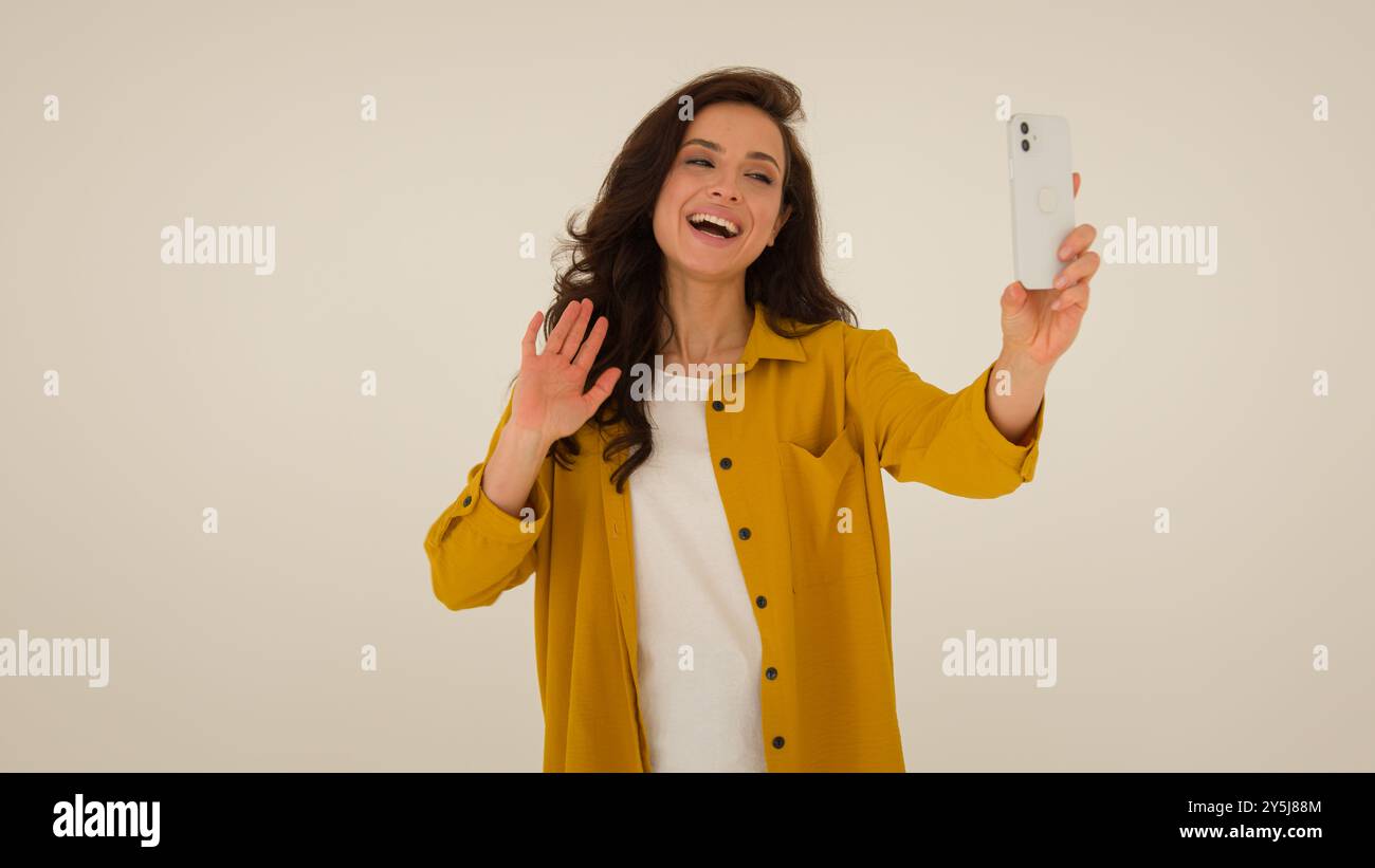 Happy Caucasian woman vlogger influencer streamer waving hand greeting ...