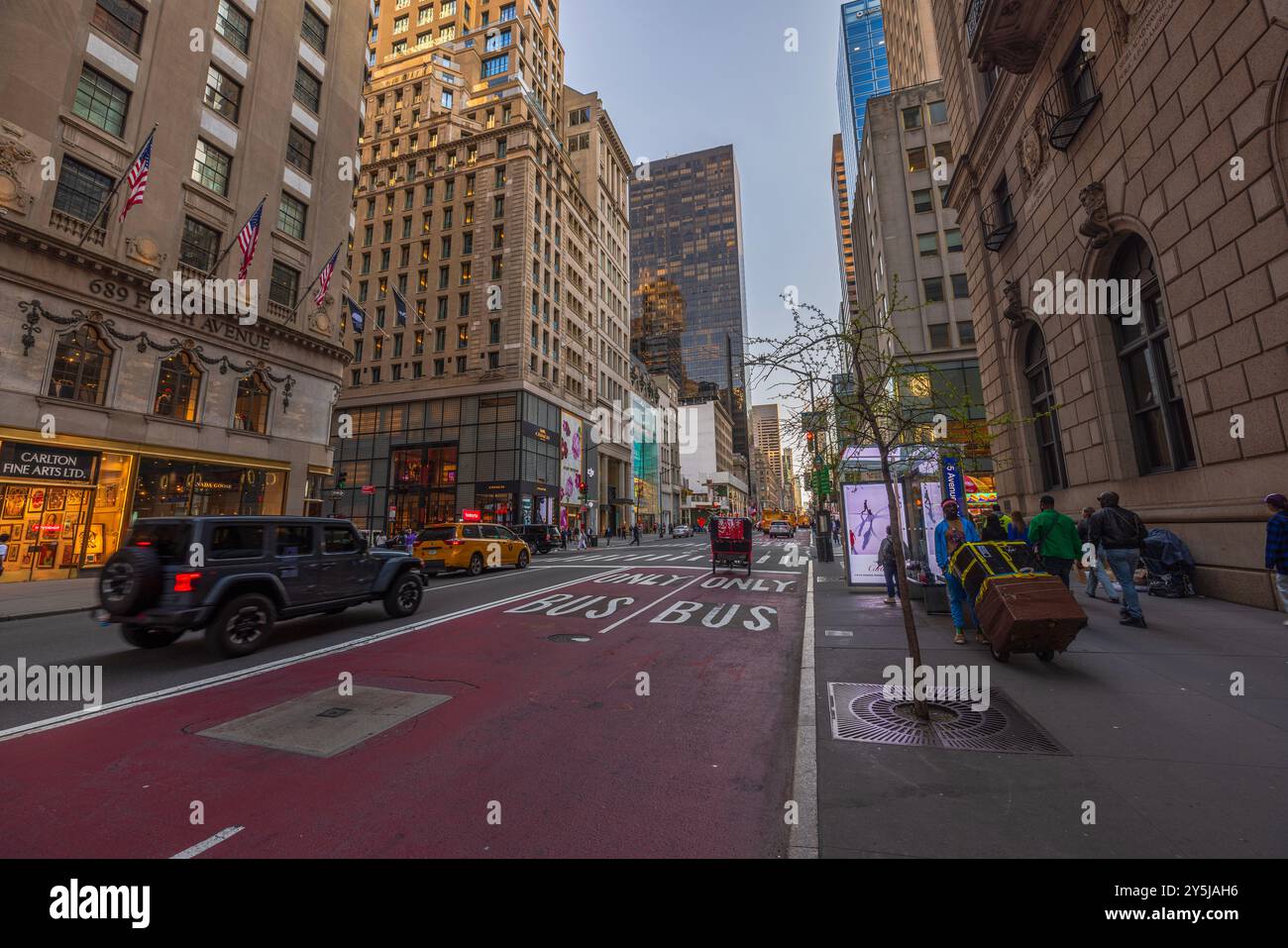 Busy street view of Fifth Avenue with cars, pedestrians, and buildings ...