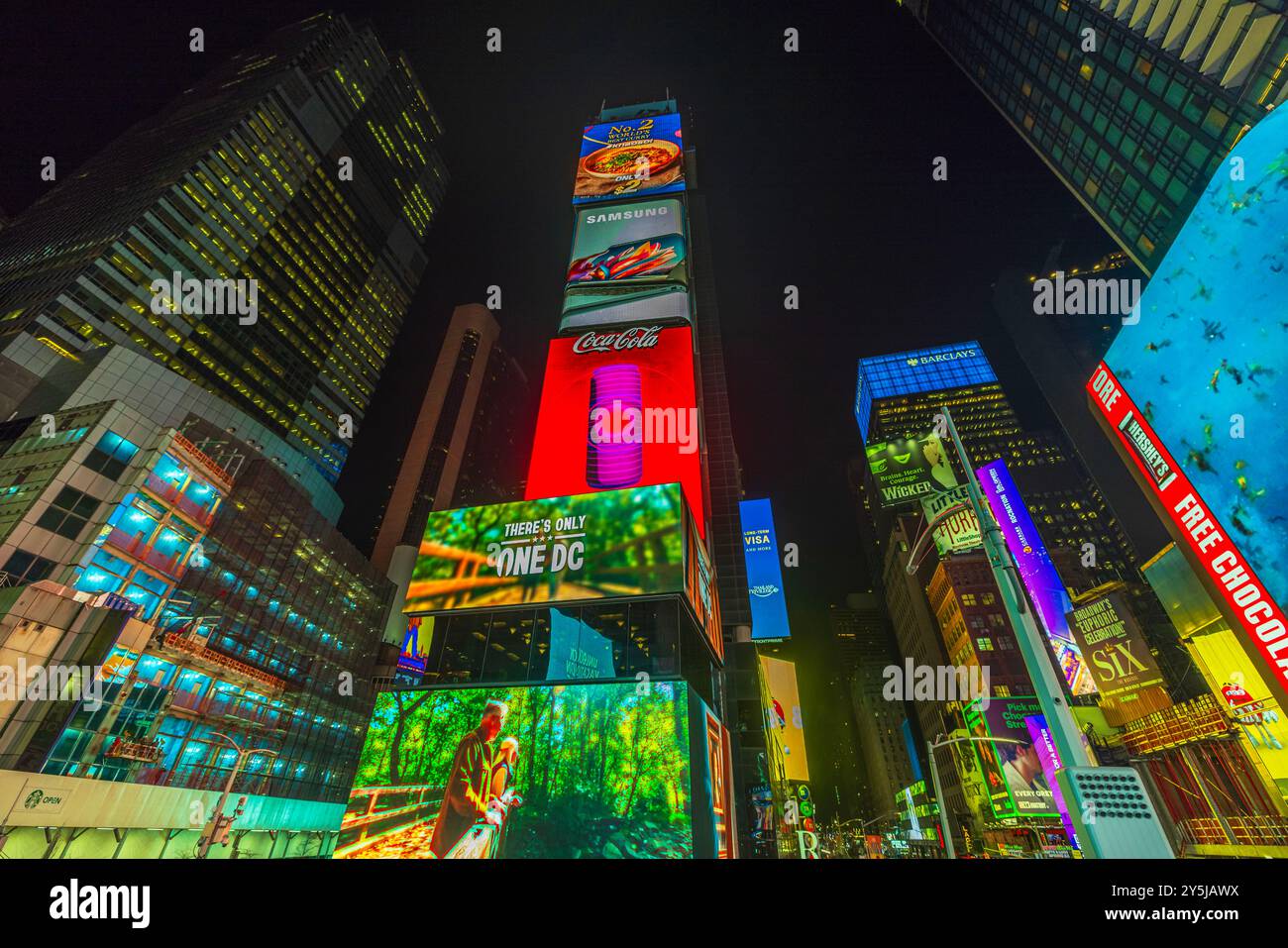 Times Square at night with illuminated billboards, including Coca-Cola ...