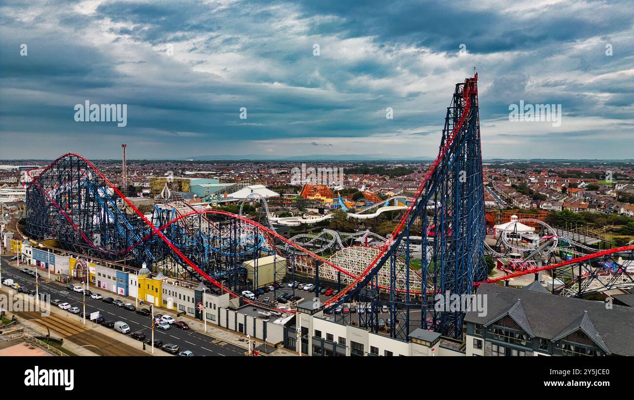 Aerial view of a vibrant amusement park featuring a large roller ...